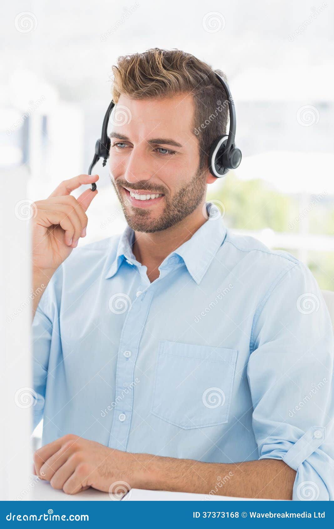 Closeup of a Casual Young Man with Headset Using Computer Stock Photo ...
