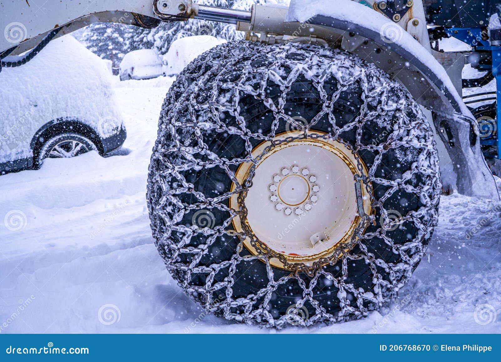 Closeup of a Chained Wheel of a Snowy Snow Plow on the Mountain Ski ... Closeup of a Chained Wheel of a Snowy Snow Plow on the Mountain Ski ...