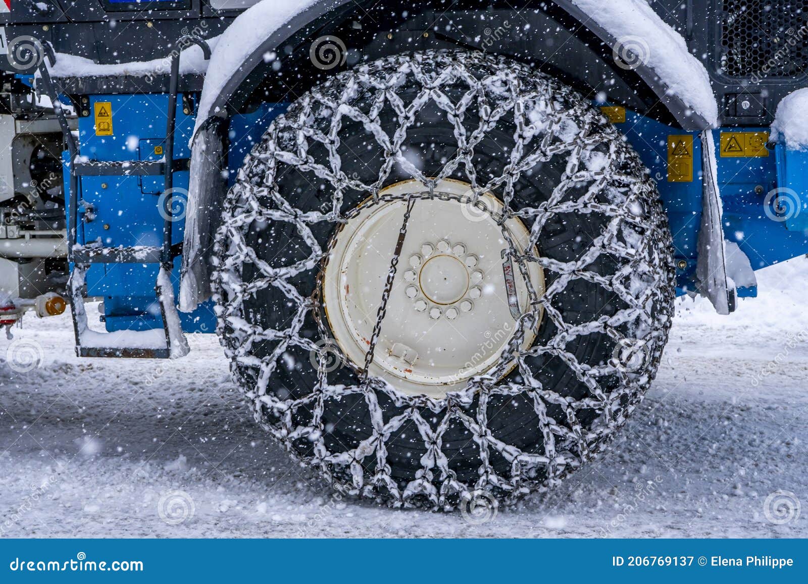 Closeup of a Chained Wheel of a Snowy Snow Plow on the Mountain Ski ... Closeup of a Chained Wheel of a Snowy Snow Plow on the Mountain Ski ...