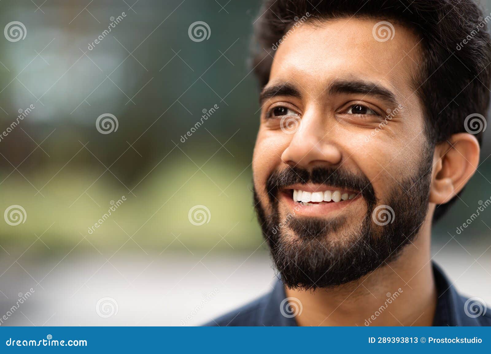 Closeup Of Cheerful Handsome Indian Guy Looking At Copy Space Stock