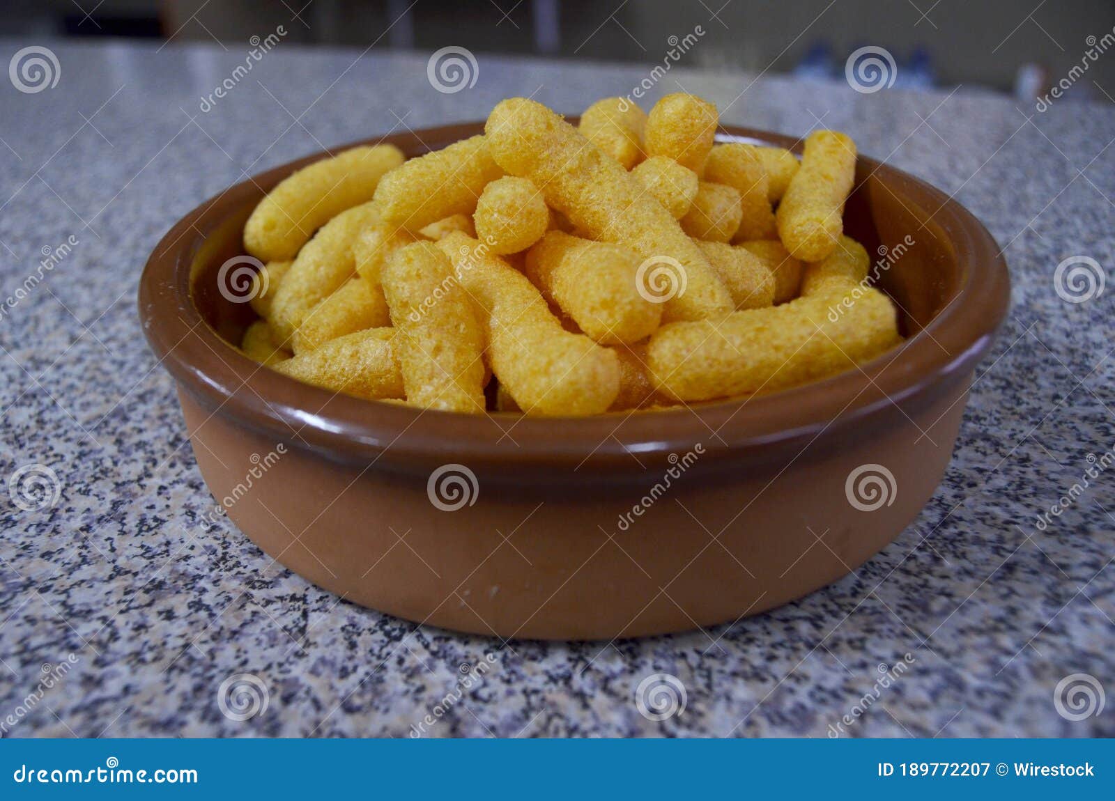 Closeup of Cheese Puffs in a Bowl on the Table Under the Lights Stock ...