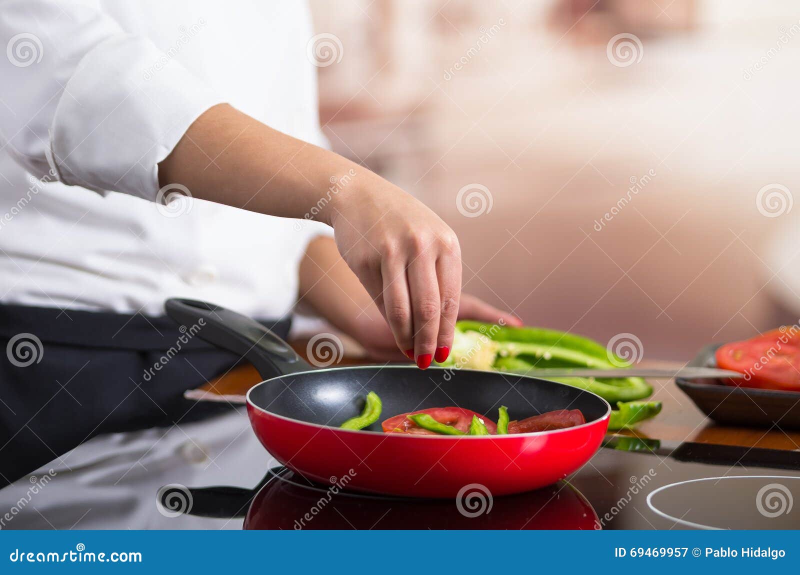 Closeup Chef Hand Adding Salt To Vegetables Frying Inside Red Skillet ...