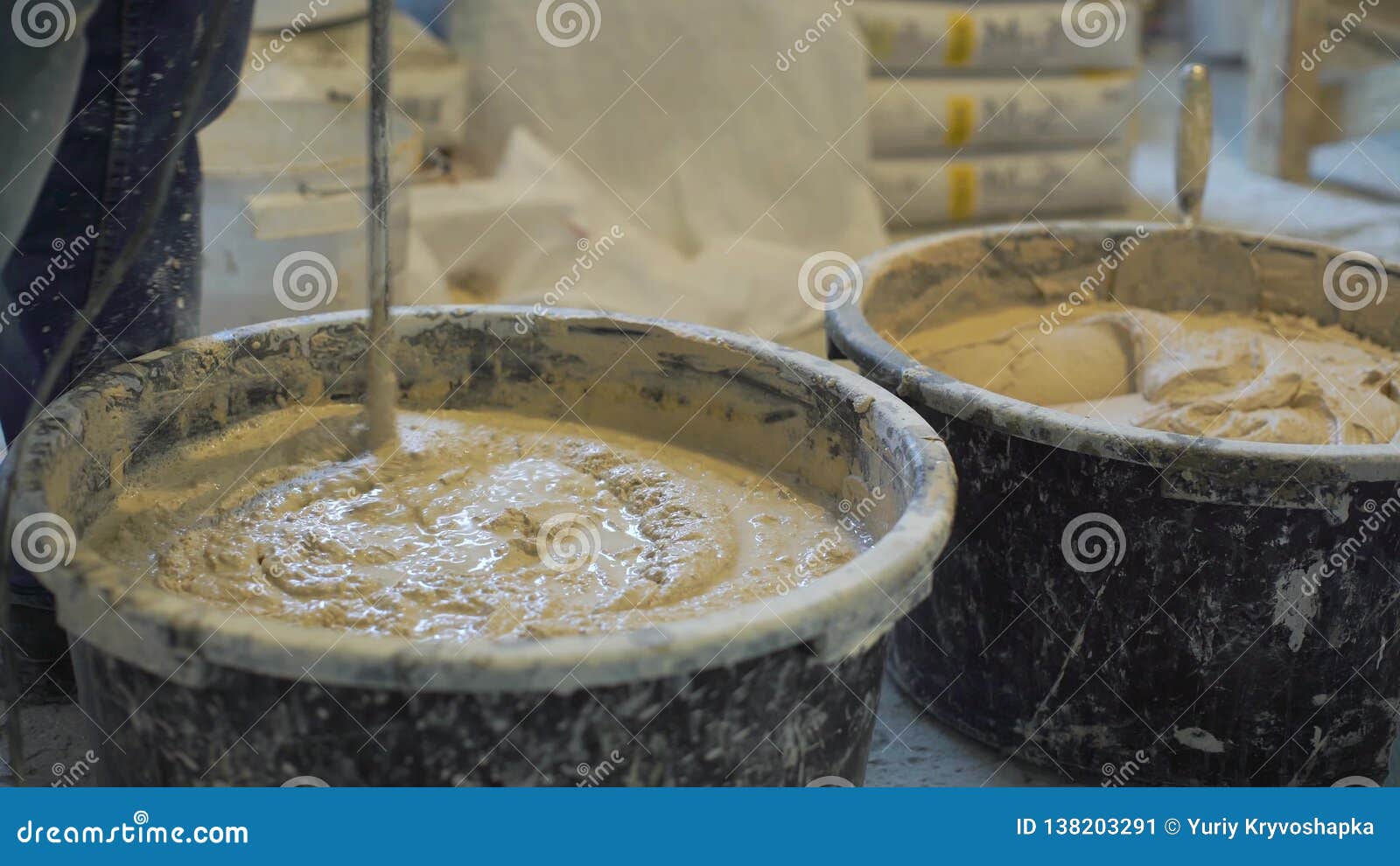 Closeup of Construction Workers Mixing Plaster Solution with Electric ...