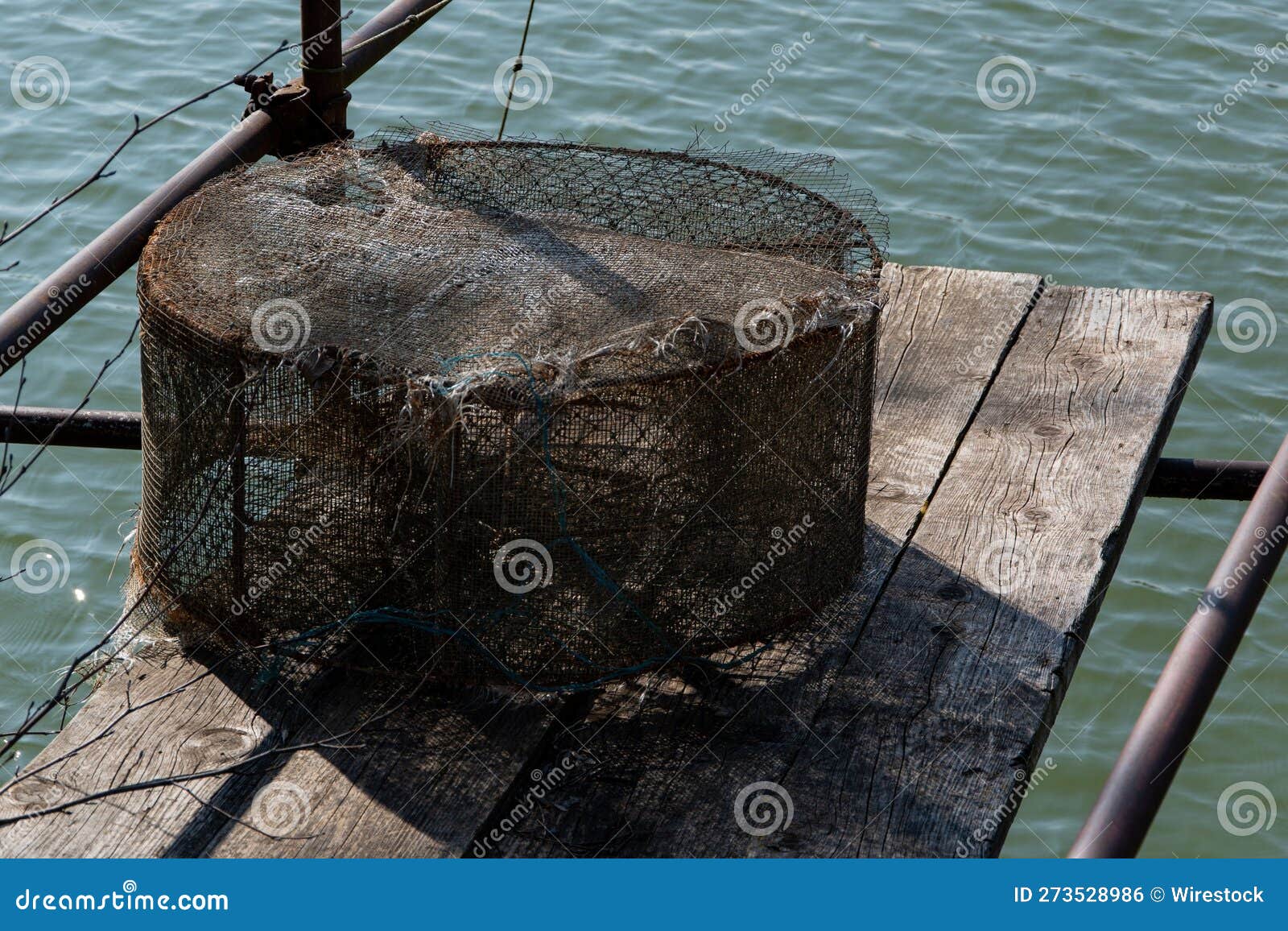 Closeup of a Crab Trap on a Wooden Dock on the Water Stock Photo ...