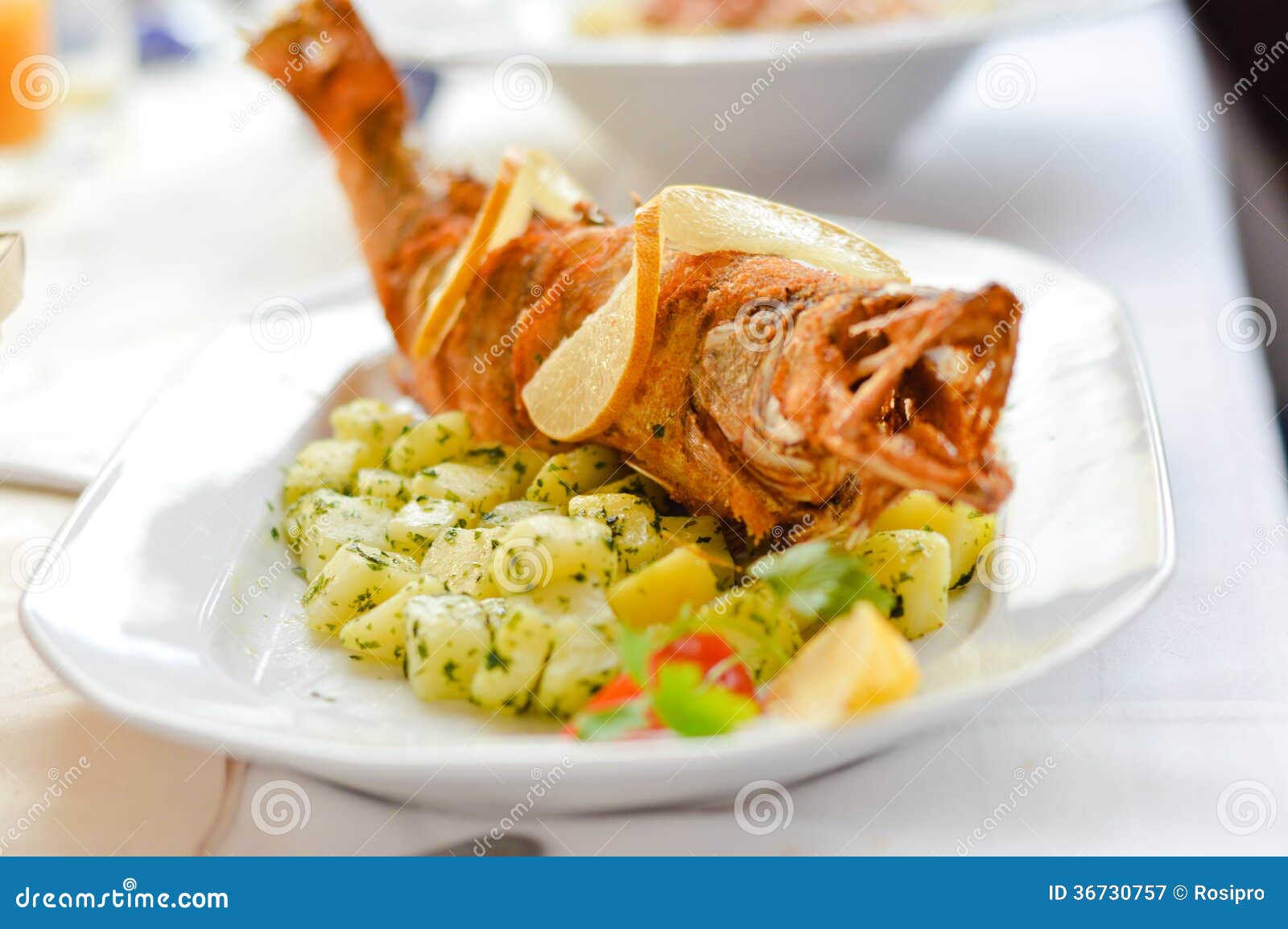 Closeup on Deep Fried Pike Fish on Boiled Potato Pillow with Butter and ...