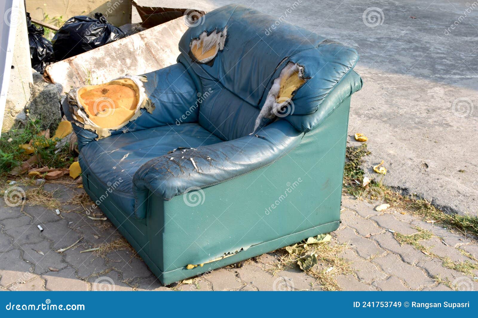 Dirty Old Colorful Sofa is Left with Garbage on the Side of the Road ...