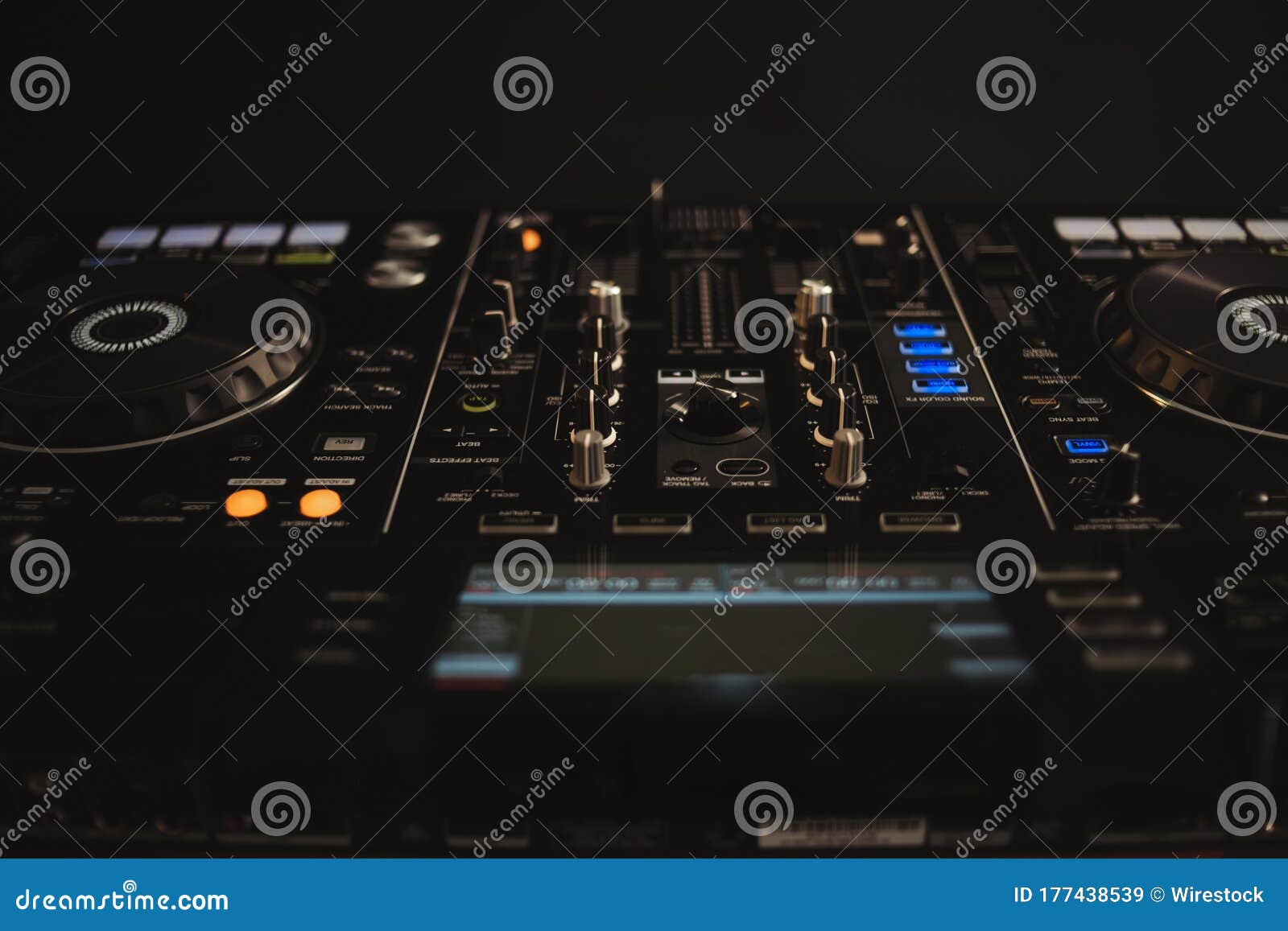 Closeup of DJ Equipment Under the Lights Against a Dark Background in a ...