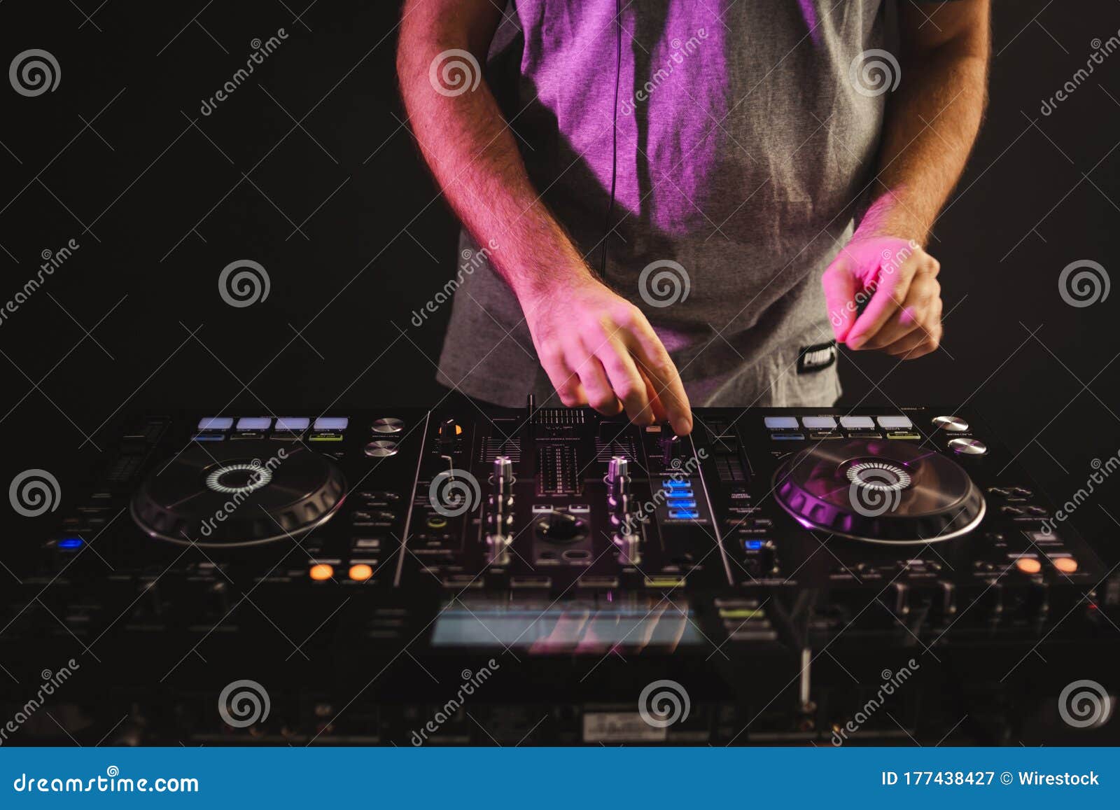 Closeup of a DJ Working Under the Colourful Lights in a Studio Stock ...