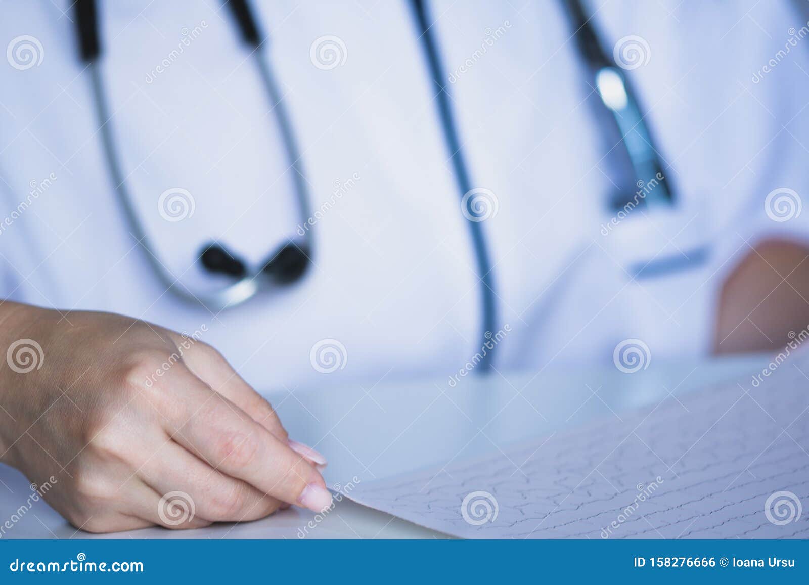 Cardiologist Reading An Ecg Print Out Doctor Analyzing