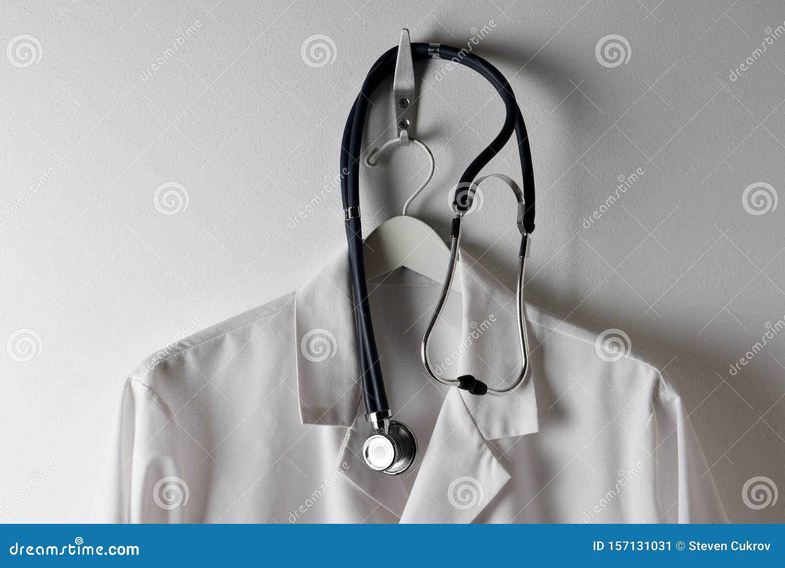 Closeup Doctors White Lab Coat Hanging on a Hook with Stethoscope ...