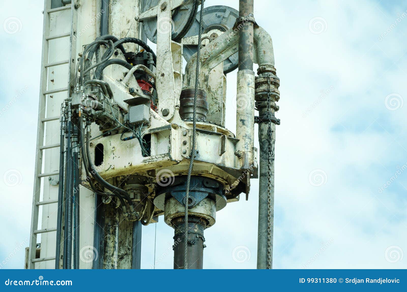 A Closeup Of A Hydraulic Fracturing Wellhead With A Flare Stack Burning ...