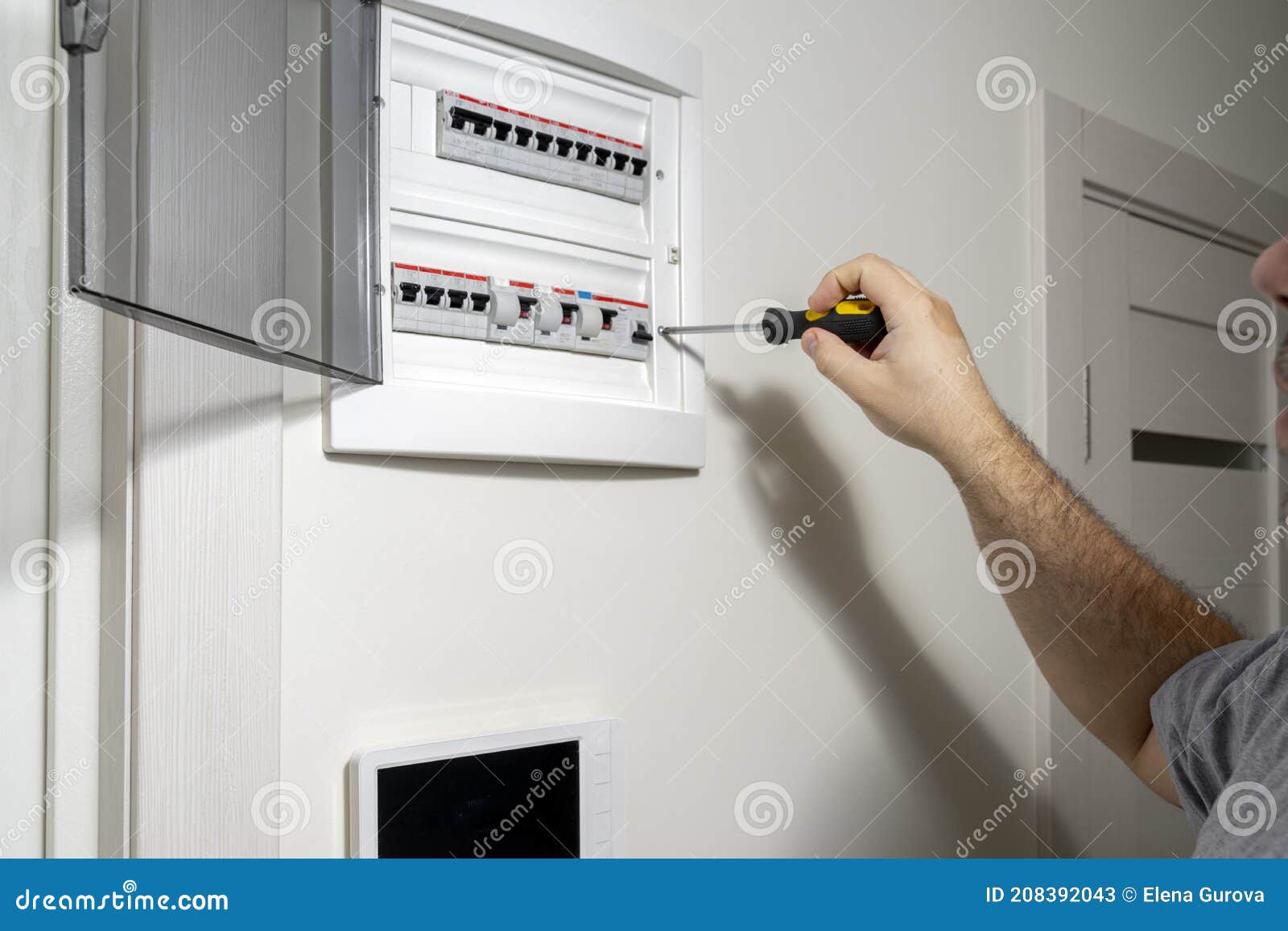 A Closeup of an Electrical Engineer Working in a Power Electrical Panel ...