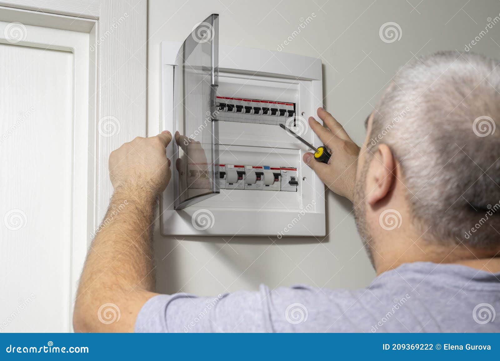 A Closeup of an Electrical Engineer Working in a Power Electrical Panel ...