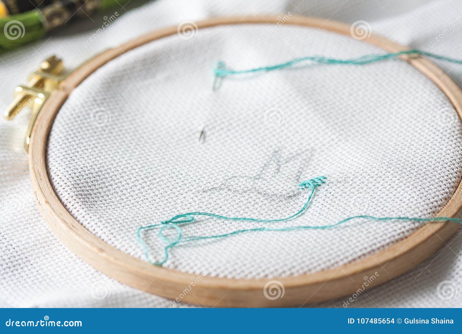 Closeup of an Embroidery Process, a Green Thread in a Needle. Wooden ...
