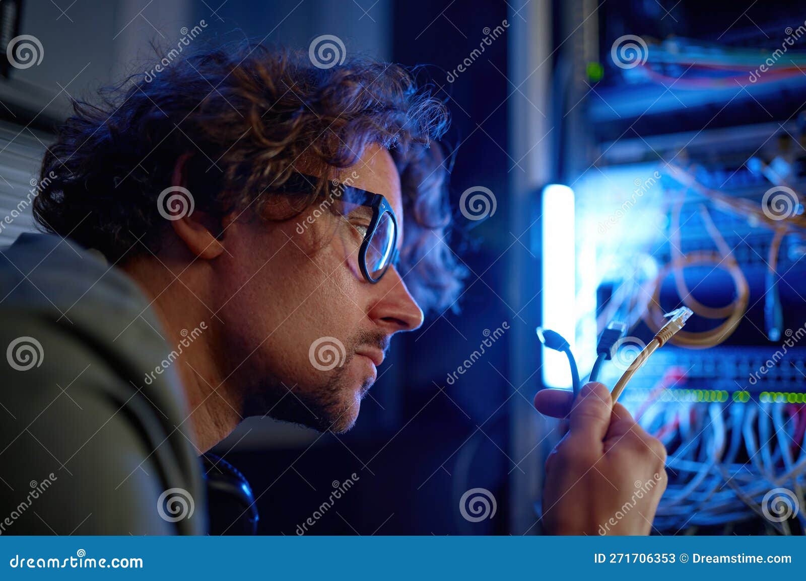 Closeup Face of Male Network Engineer Connecting Cables in Server Room ...