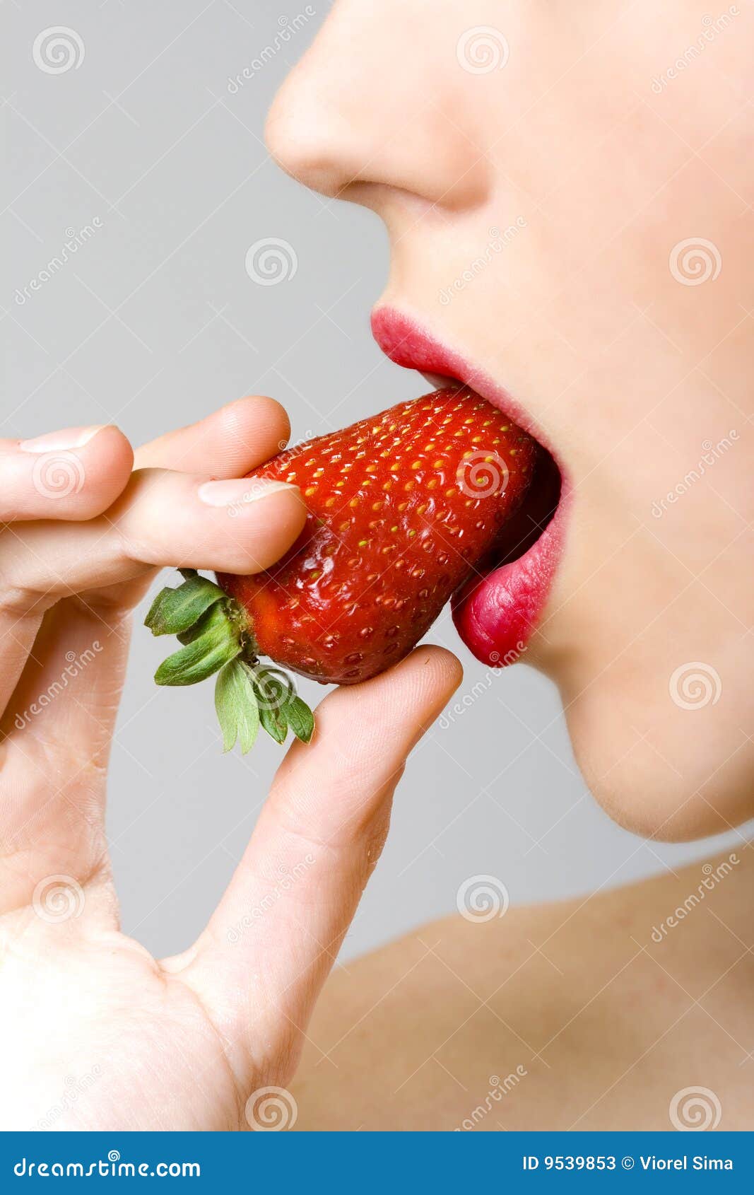 Closeup of Female Face Biting a Strawberry Stock Image - Image of ...