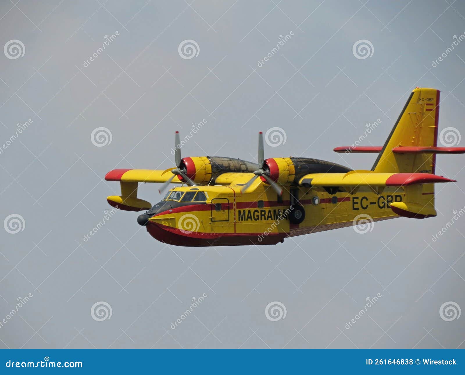 Closeup of a Firefighting Aircraft in Yellow and Red Flying in the Blue ...