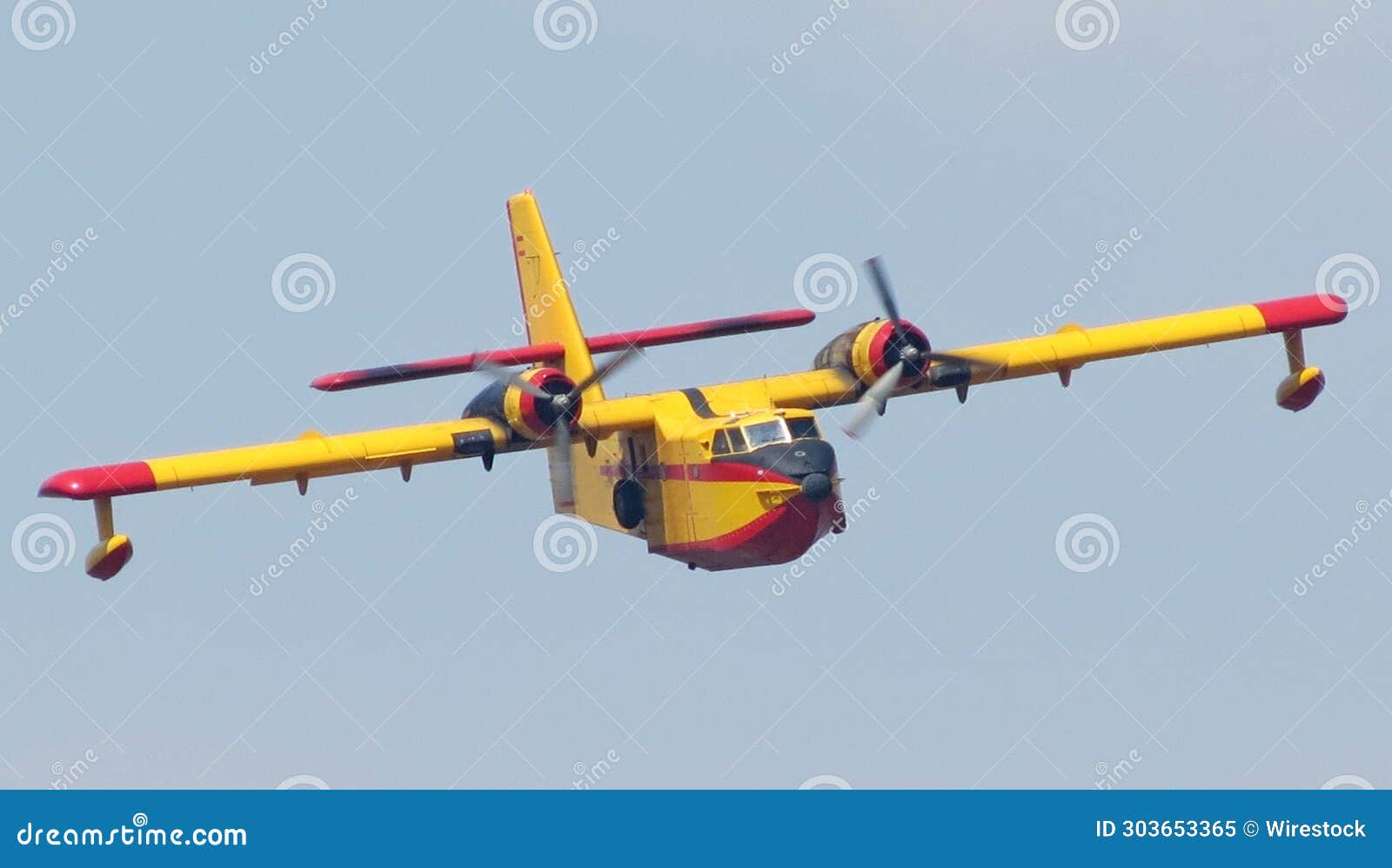 Closeup of a Firefighting Aircraft in Yellow and Red Flying in the Blue ...