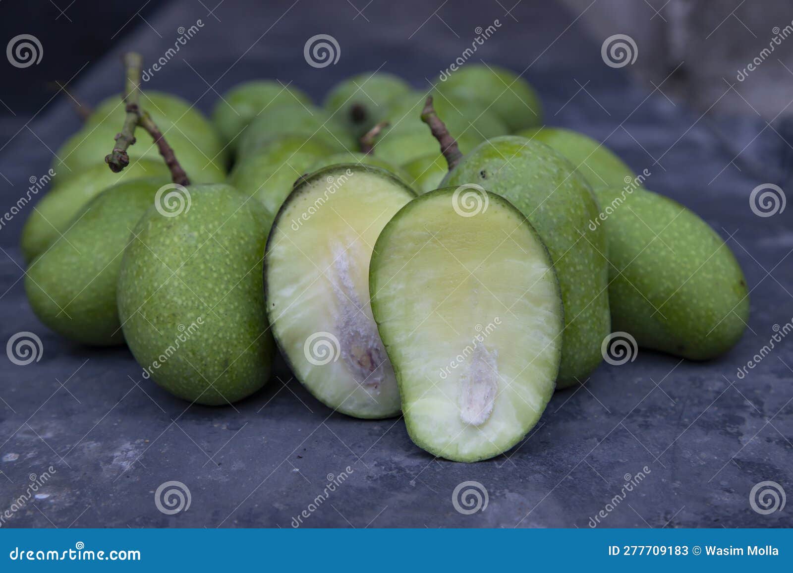Closeup Focus Fresh Raw Mango with Sliced Mango on the Concrete Floor ...