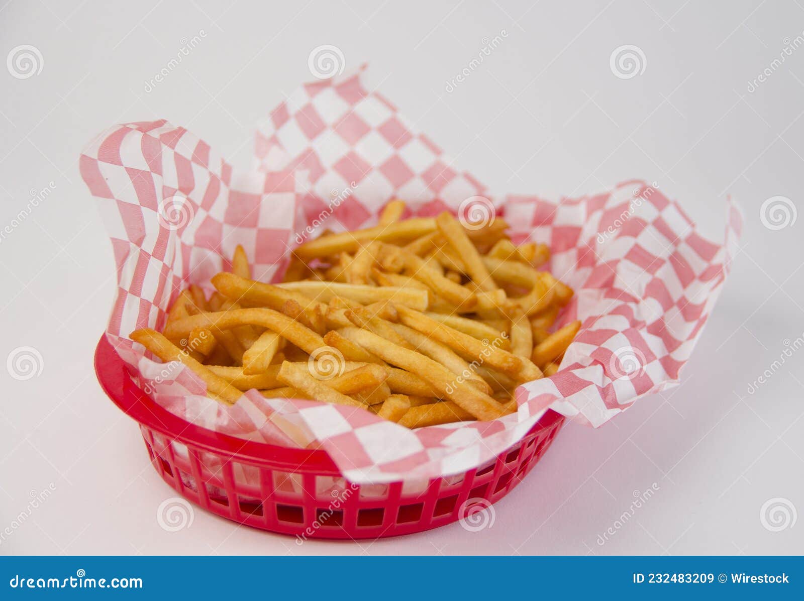 Closeup of French Fries in a Plastic Basket with a Checkered Pattern on ...