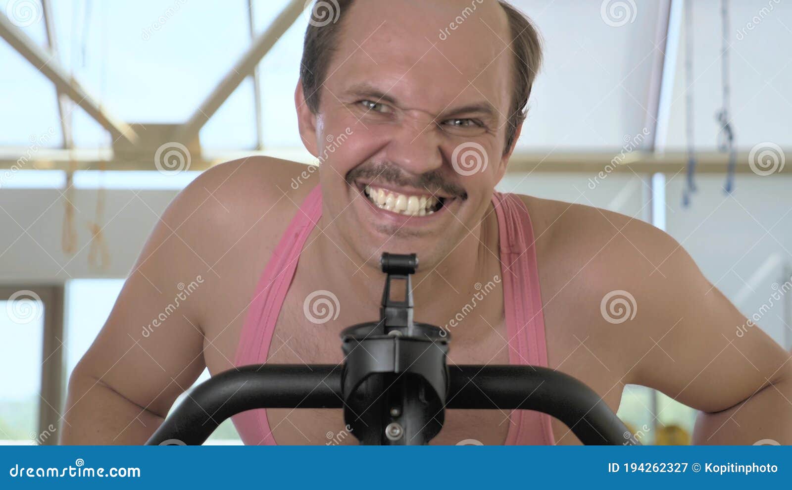 Closeup, Funny Bald Man is Training on an Exercise Bike, Smiling Stock ...