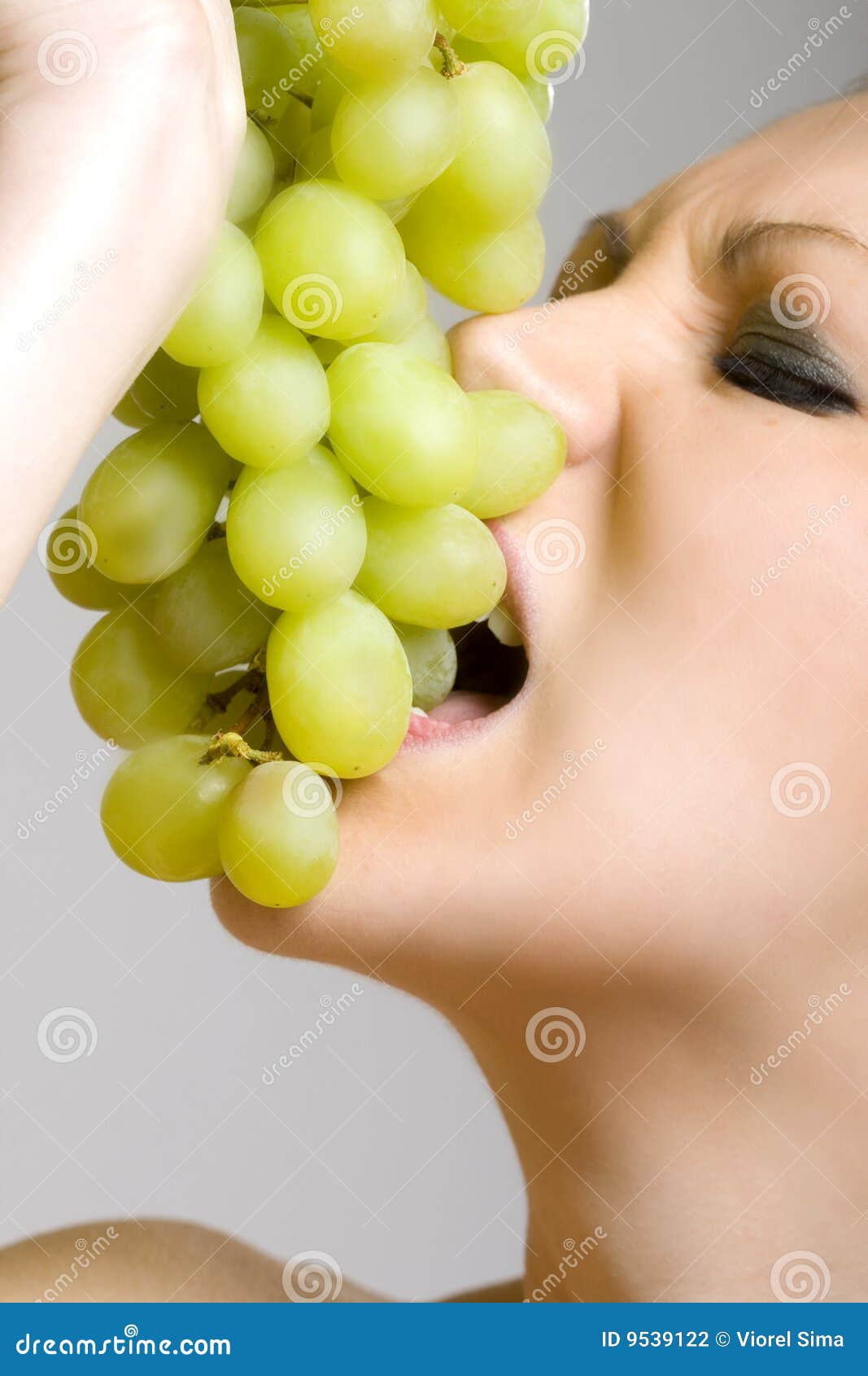 Closeup of a Girl Biting a Grape Stock Photo - Image of aphrodisiac ...