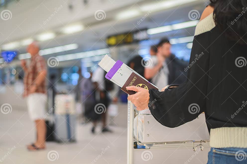 Closeup Of Girl Holding Passports And Boarding Pass At Airport Stock