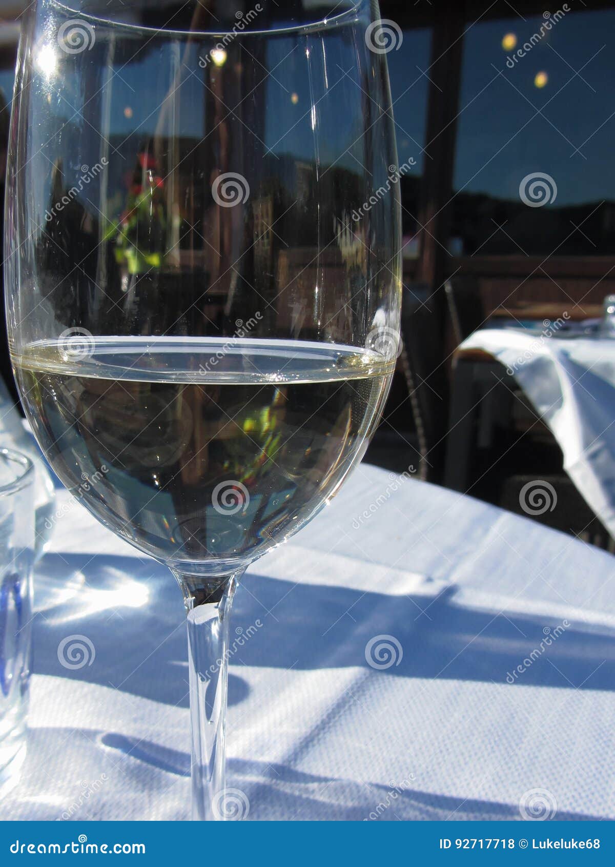 Closeup of Glass with White Wine and Light Reflections on a Table ...