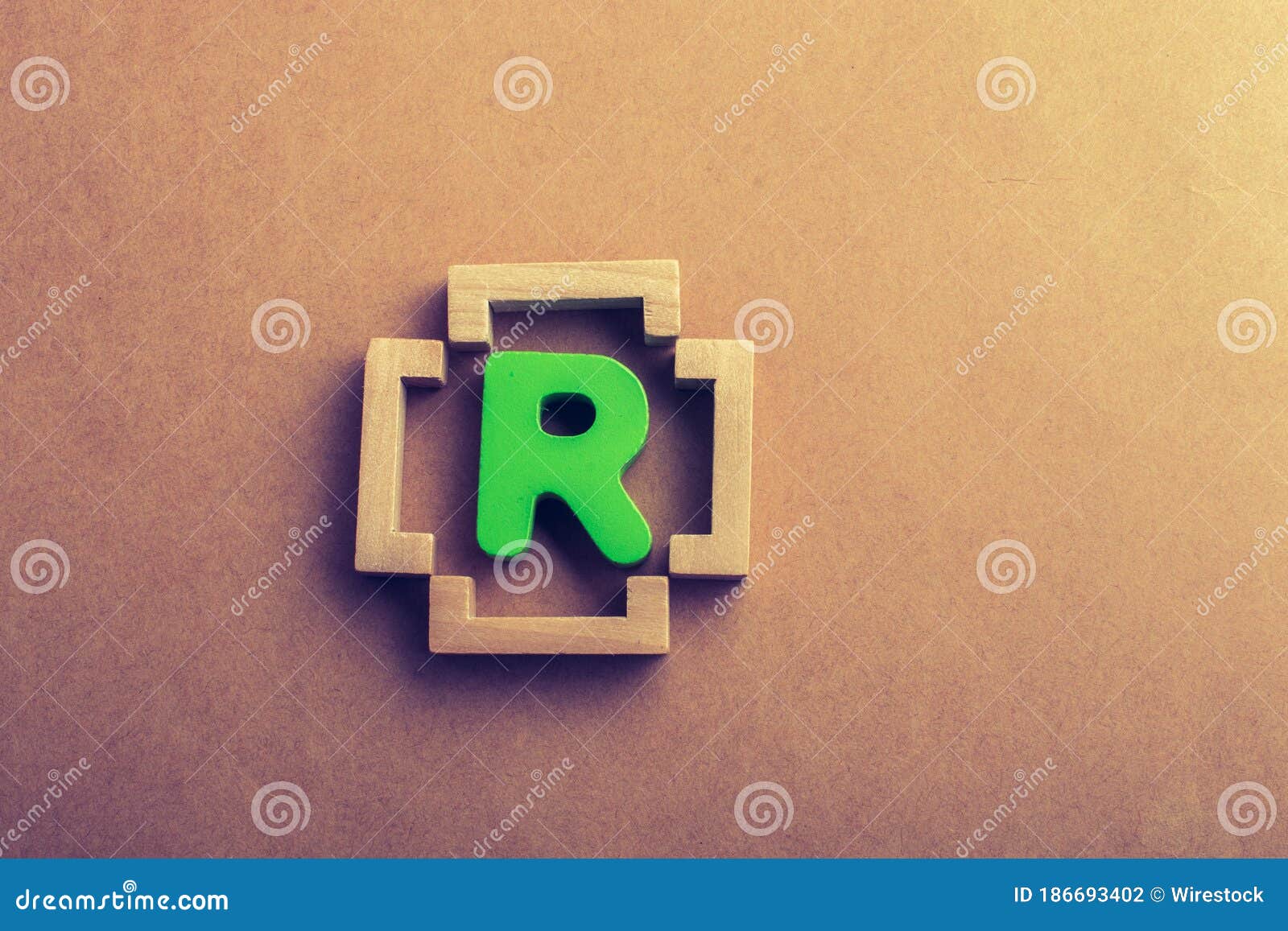 Closeup of Green Letter Cube R Made of Wood on a Light Brown Surface ...