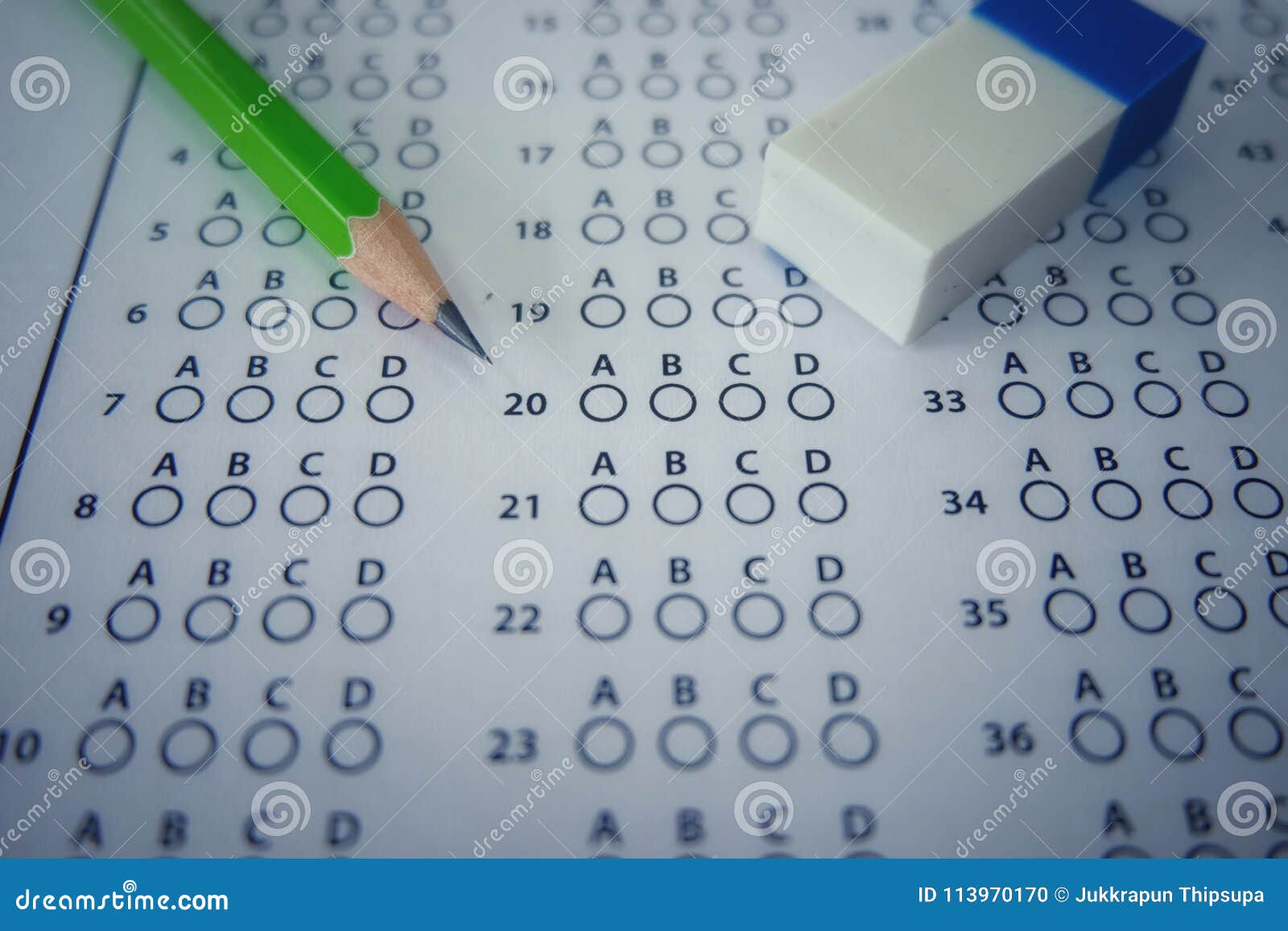 Closeup a Green Pencil and White - Blue Eraser on Answer Sheet. Stock ...