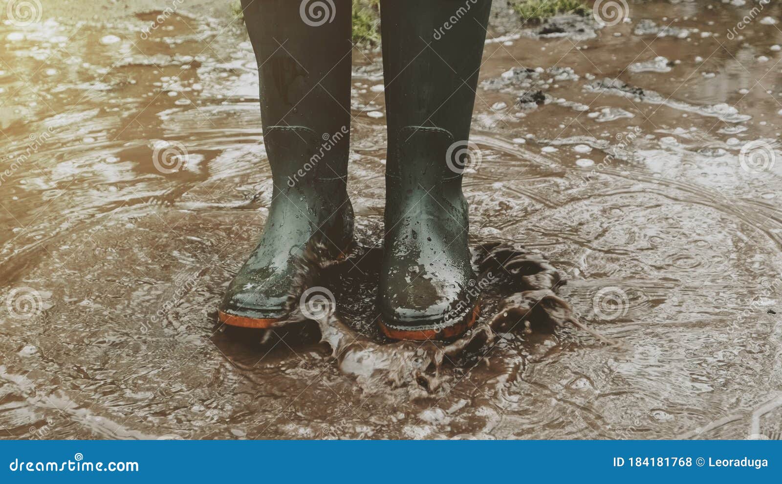 Closeup of Green Rain Boots Splashing in a Muddy Puddle after the Rain ...