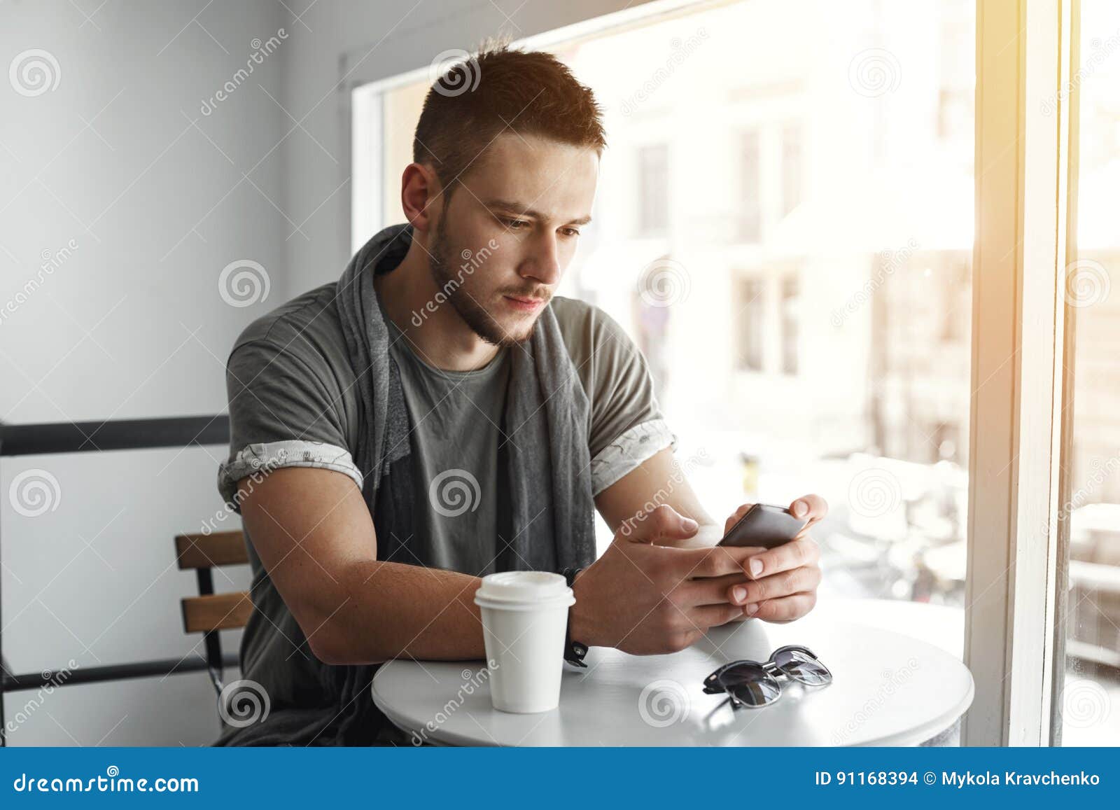 Closeup of Guy Sitting at Table in Cafe, Texting Message. Stock Photo ...