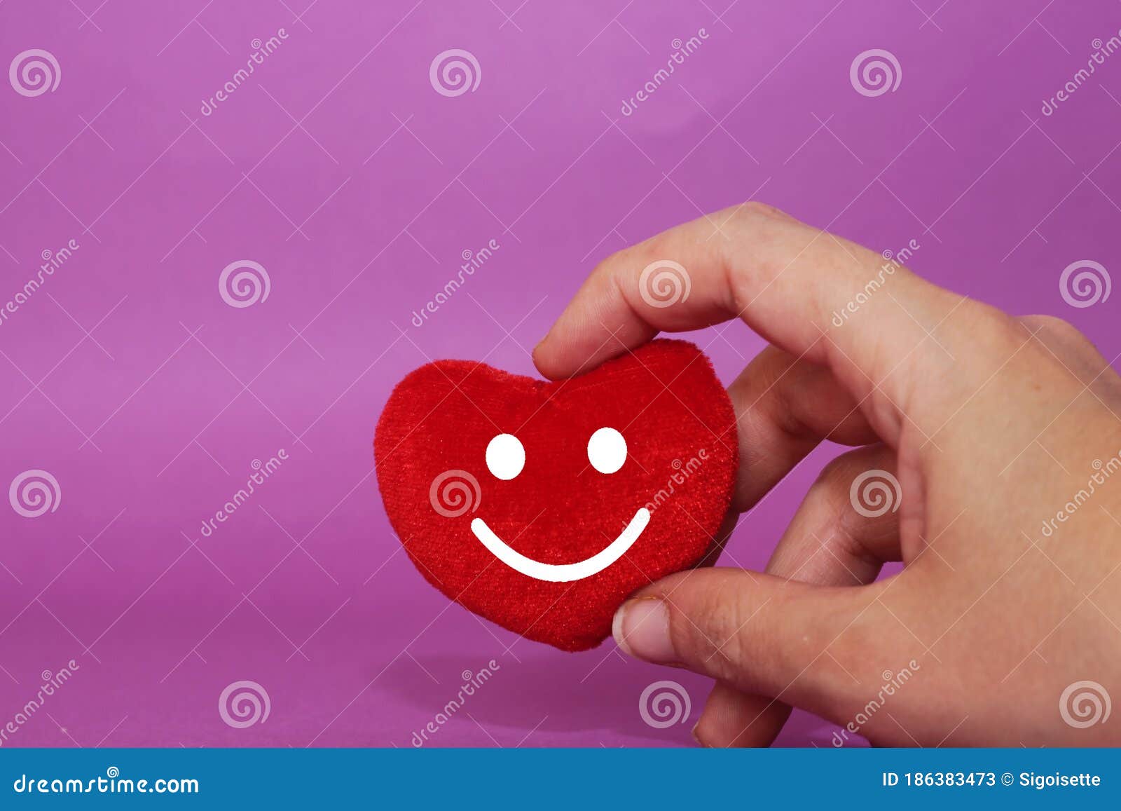 Closeup Hand Holding Heart Cotton Shape with Smiley Face. Service ...