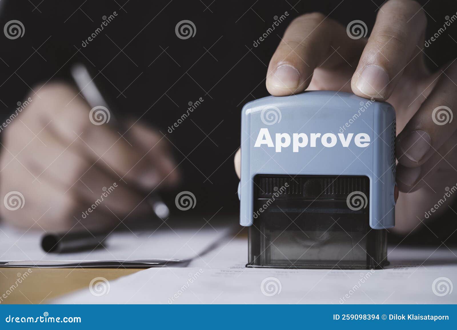 Closeup of Hand Holding Stamping for Approve Document on Table for ...