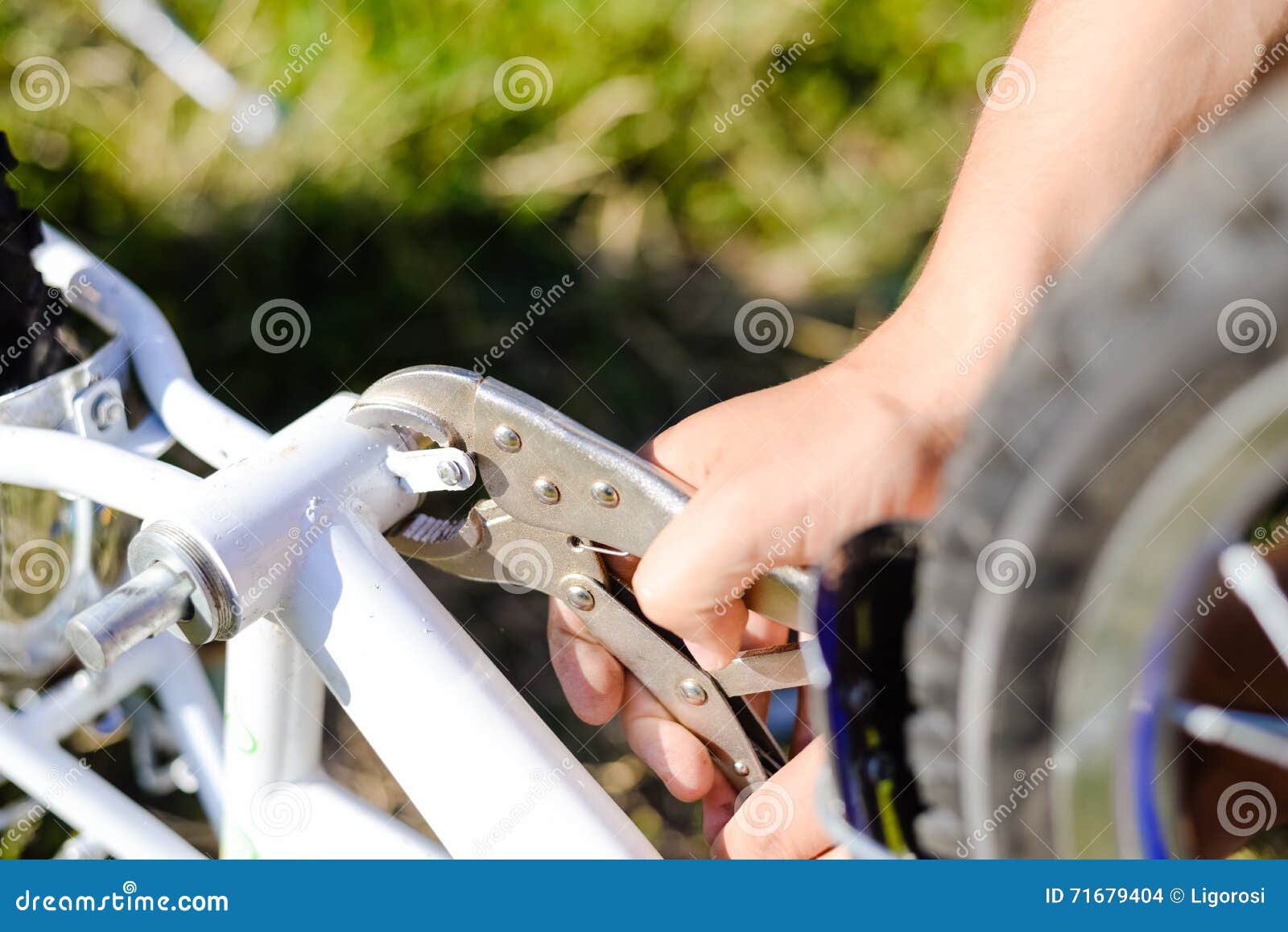 Closeup on Hands of Father Fixing Mechanism of the Bicycle, Green ... Closeup on Hands of Father Fixing Mechanism of the Bicycle, Green ...