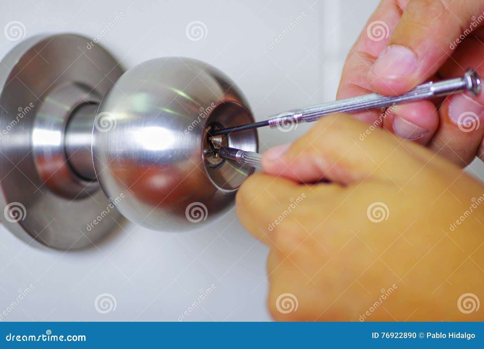 Closeup Hands of Locksmith Using Metal Pick Tools To Open Locked Door ...