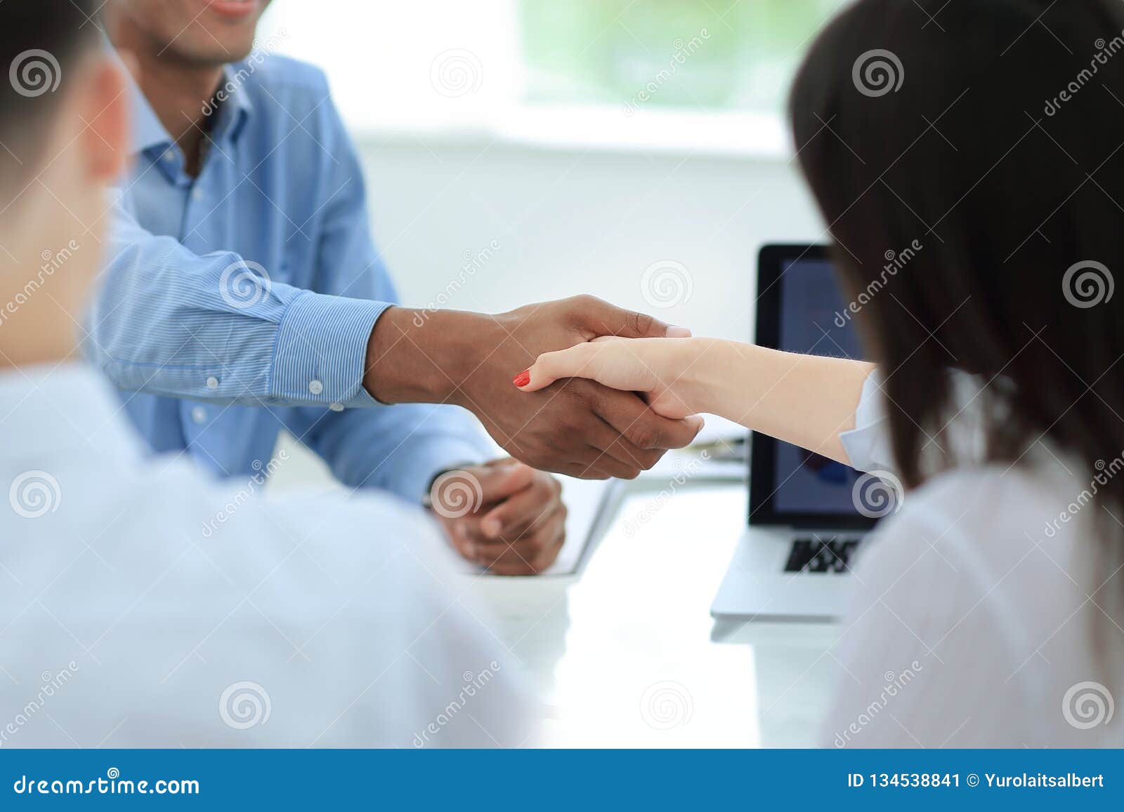 Closeup.the Handshake of Employees in the Workplace Stock Image - Image ...