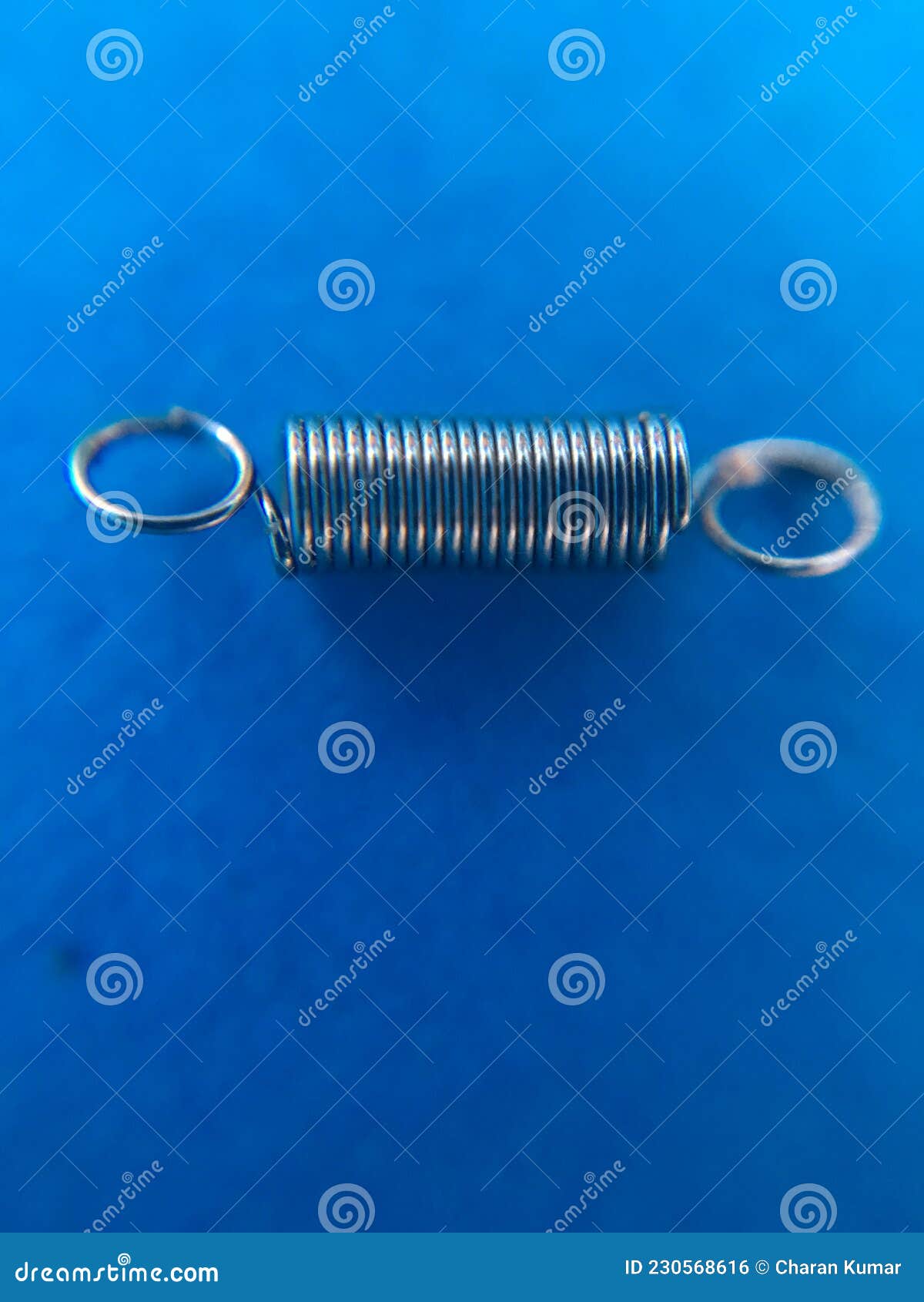 Closeup of a Helical Spring Placed on a Blue Color Paper Stock Photo ...