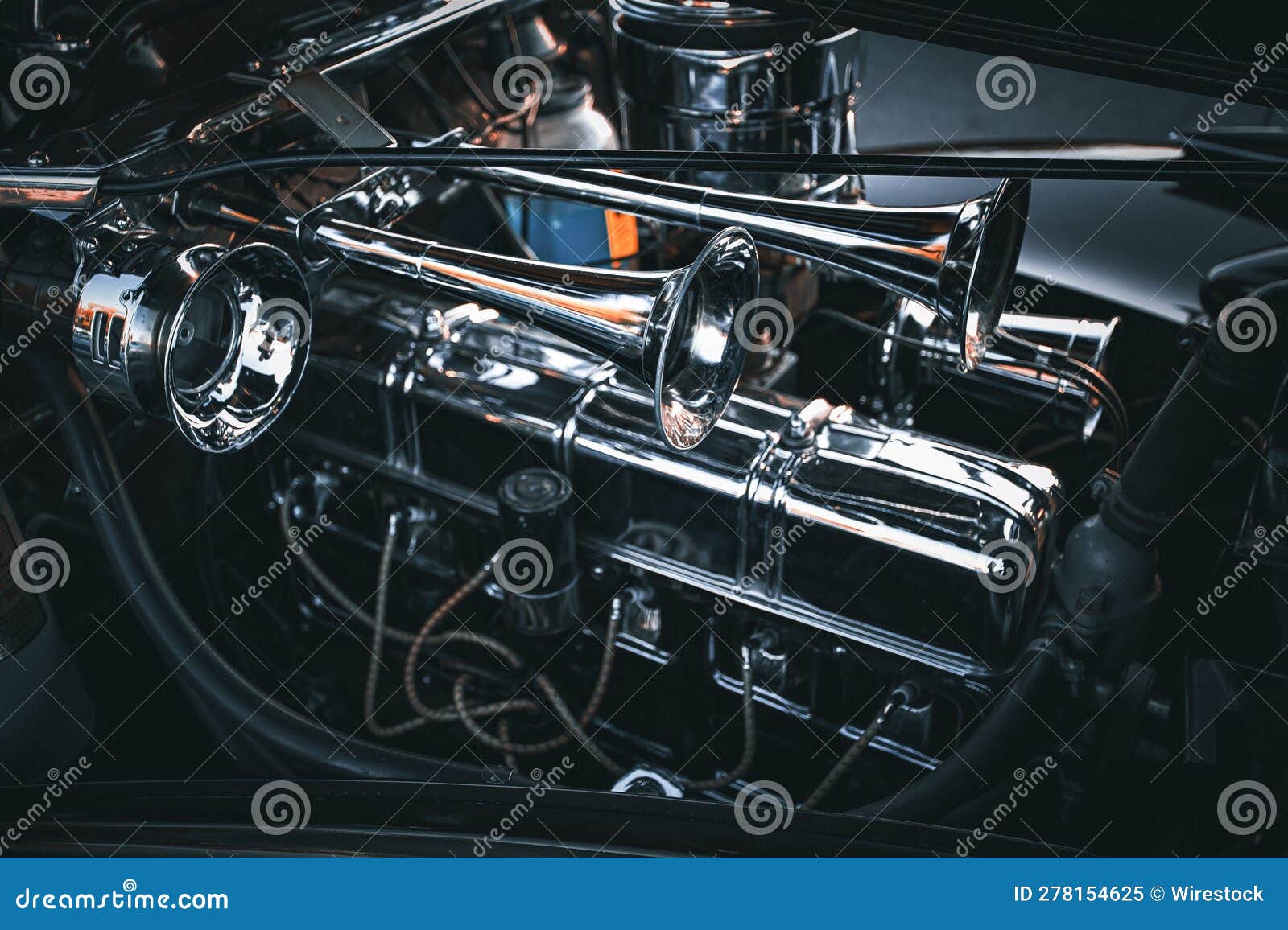 Closeup of a High-shine Chrome Car Engine in a Dark, Industrial Setting ...