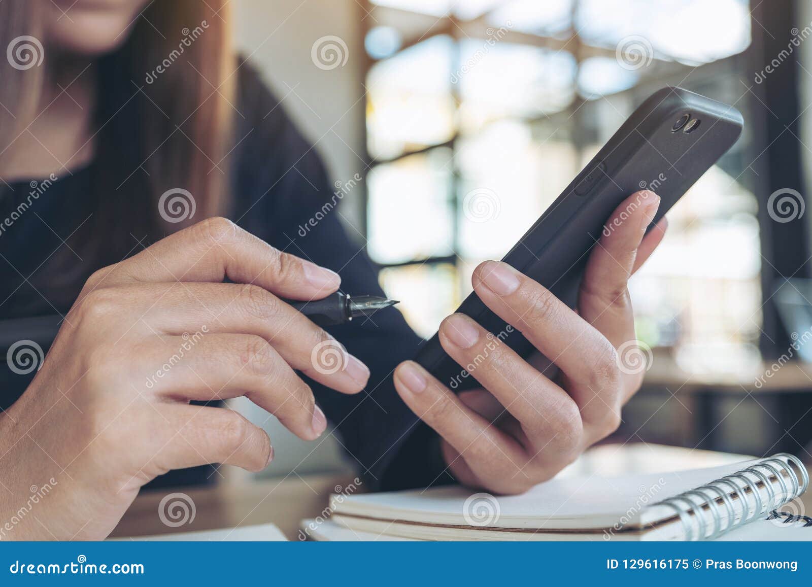 A Woman Holding , Using and Looking at Smart Phone while Working in ...