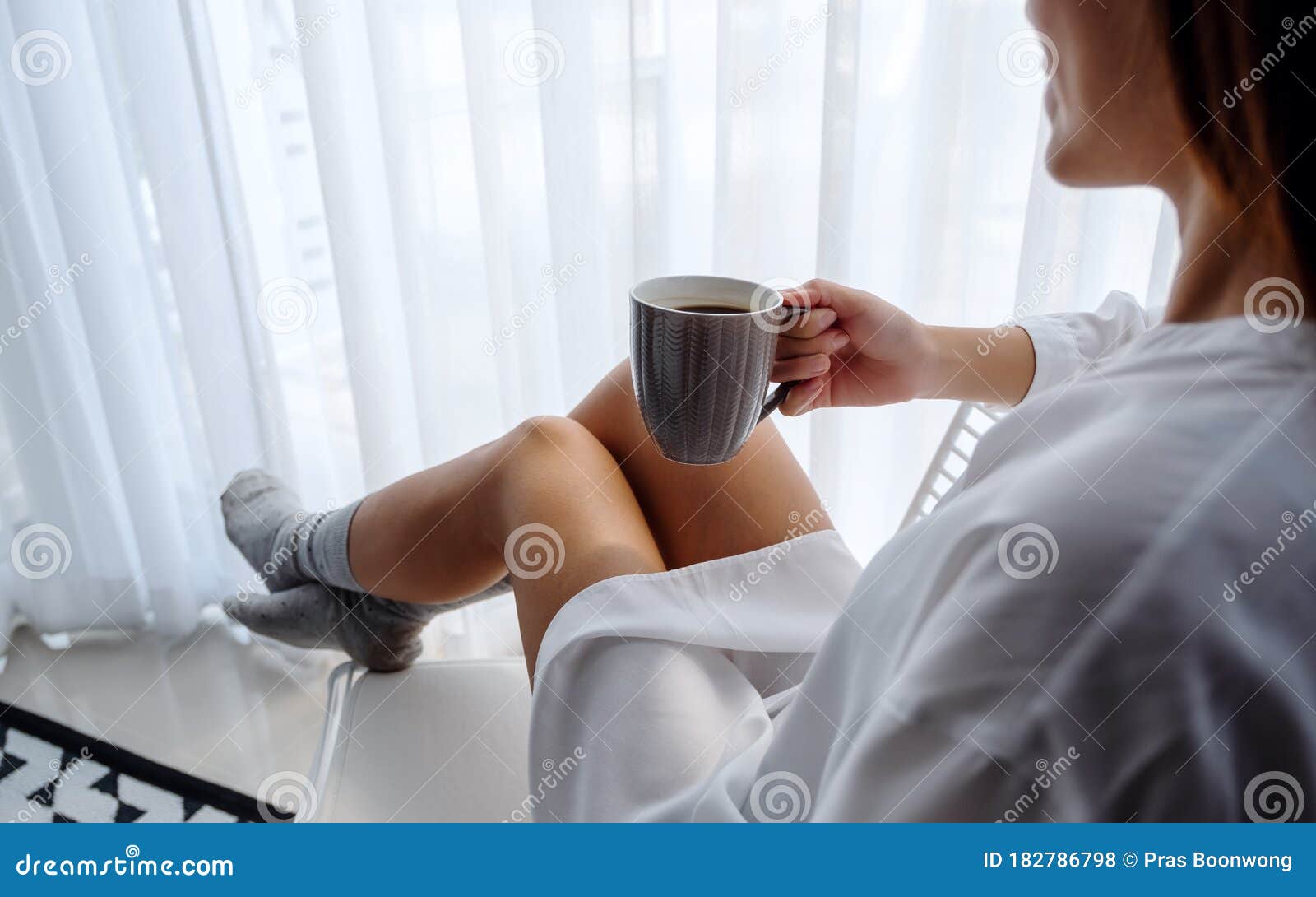 A Beautiful Woman Drinking Hot Coffee In Bedroom At Home In The Morning
