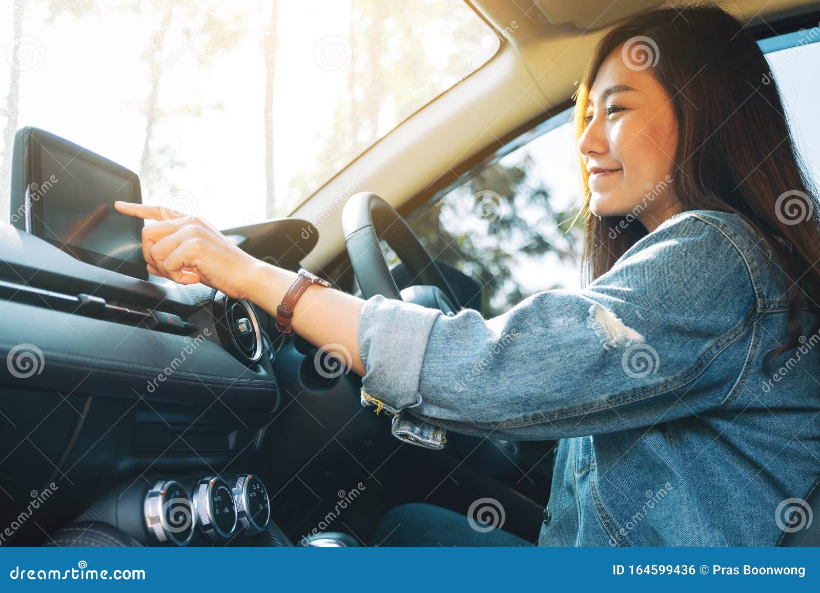 A Beautiful Woman Using and Pointing Finger at Navigation Screen while ...