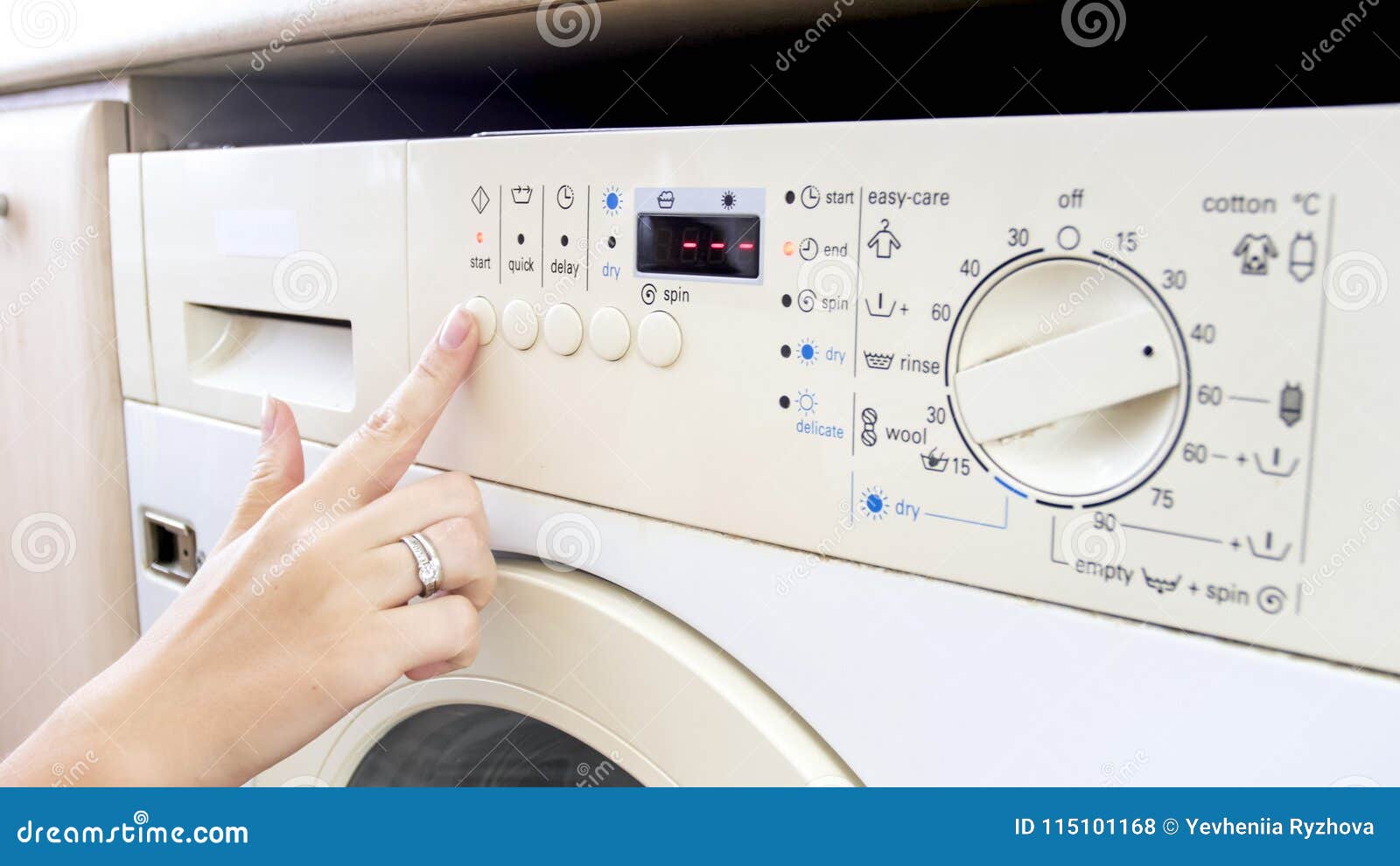 Closeup Image of Female Hand Pushing Start Button on Washing Machine ... Closeup Image of Female Hand Pushing Start Button on Washing Machine ...