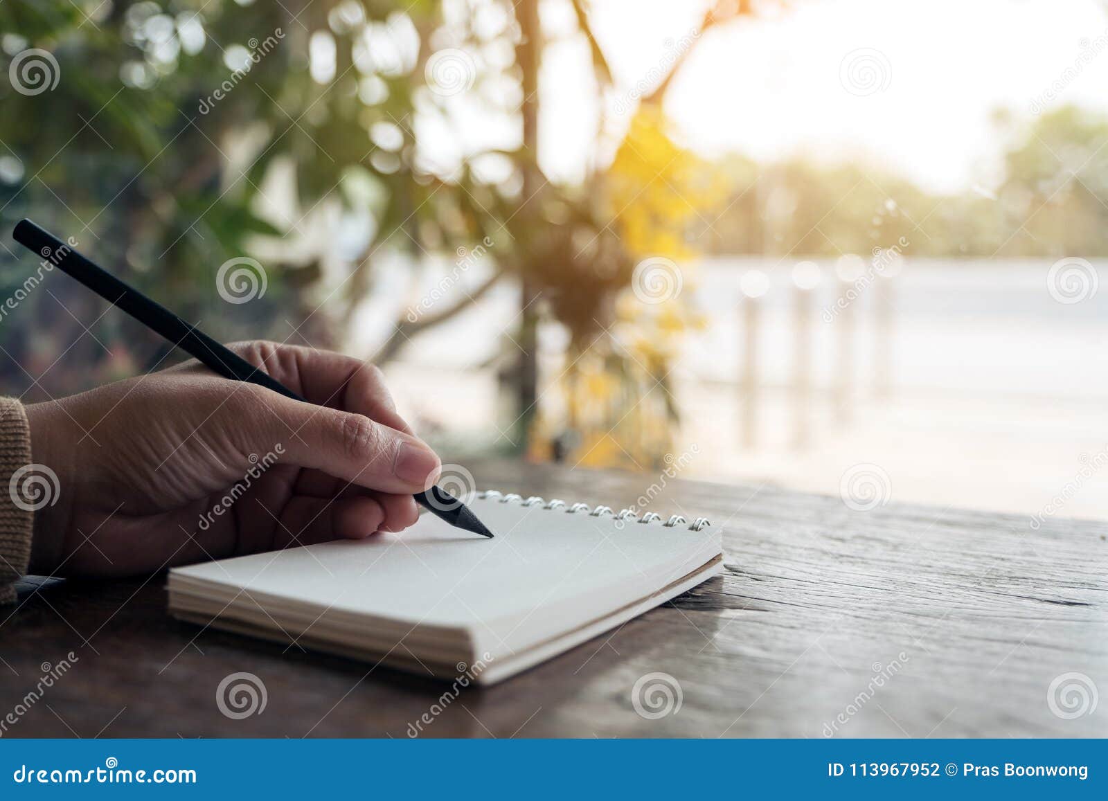 Closeup Image of Hand Writing Down on a Blank Notebook Stock Photo ...