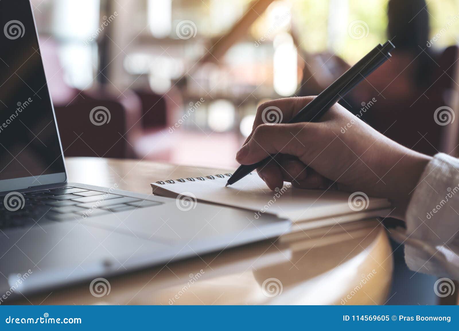 Hand Writing Down on a Blank Notebook with Laptop on Wooden Table Stock ...