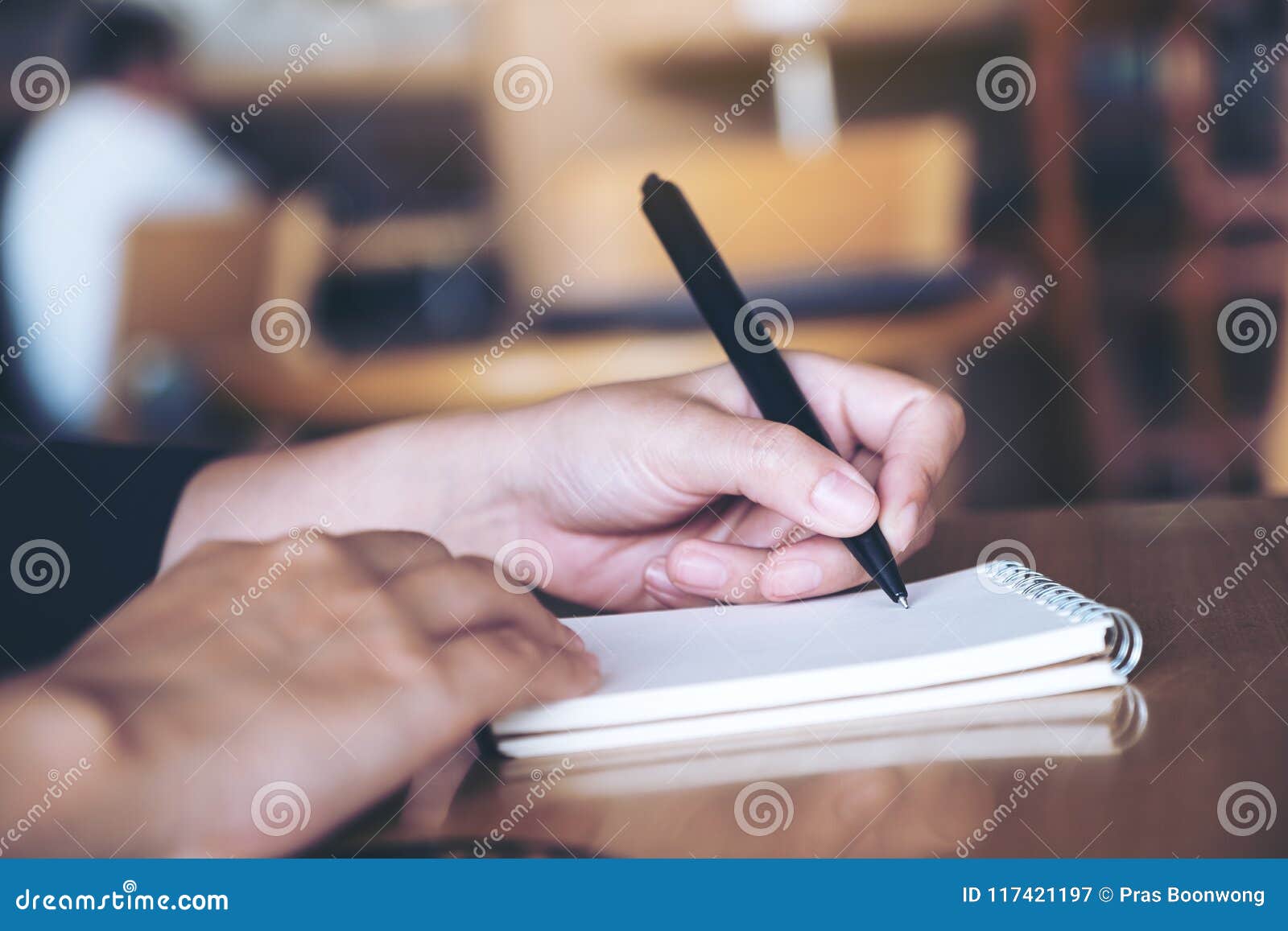 A Hand Writing Down on a White Blank Notebook on Table Stock Image ...