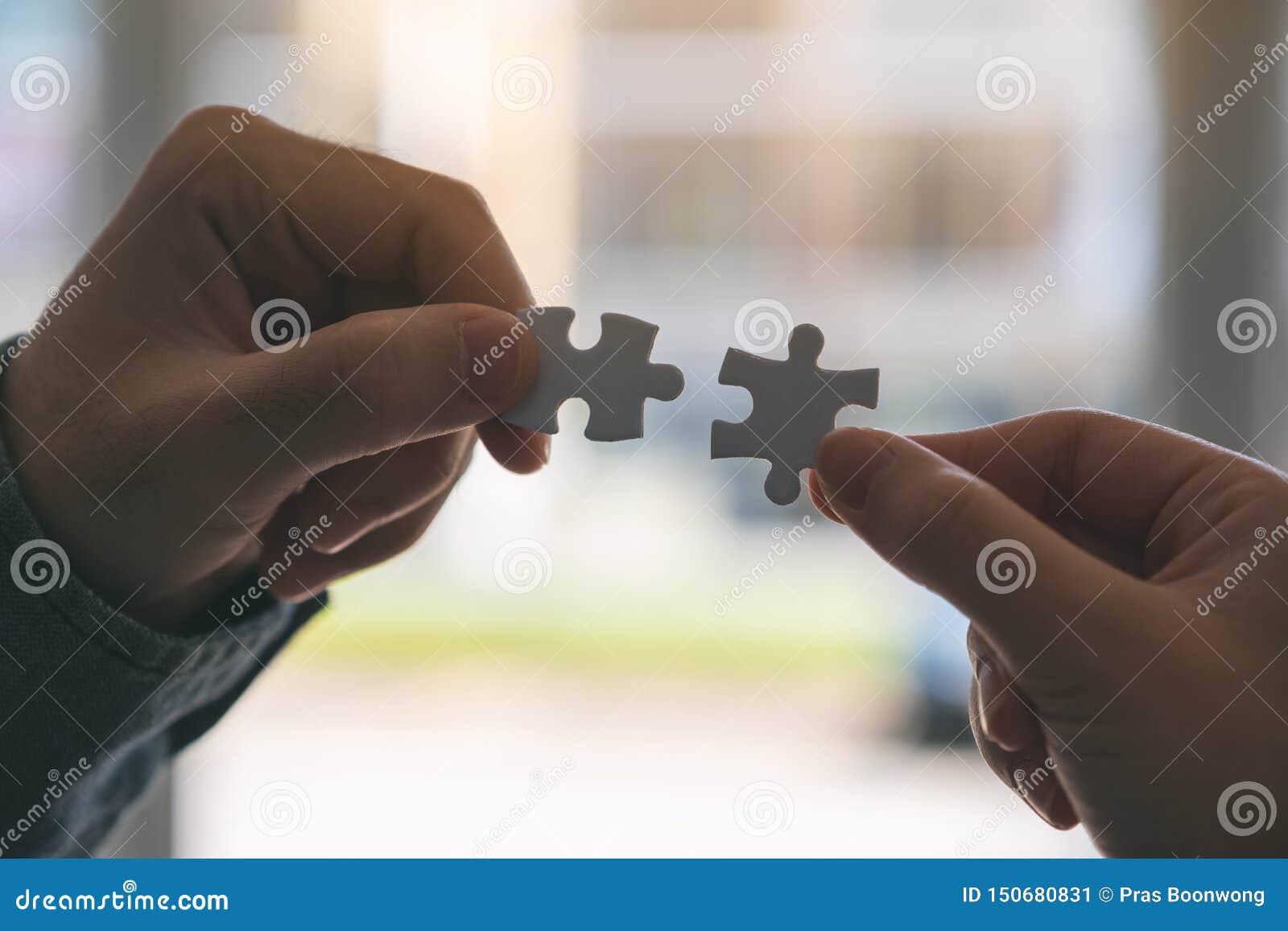 Two Hands Holding and Putting a Piece of White Jigsaw Puzzle Together ...