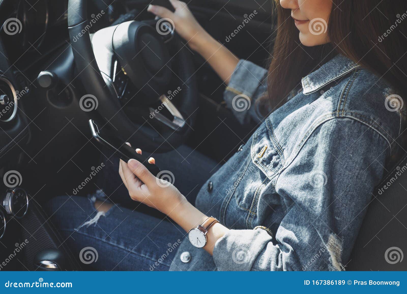 A Woman Using Mobile Phone while Driving a Car Stock Image - Image of ...