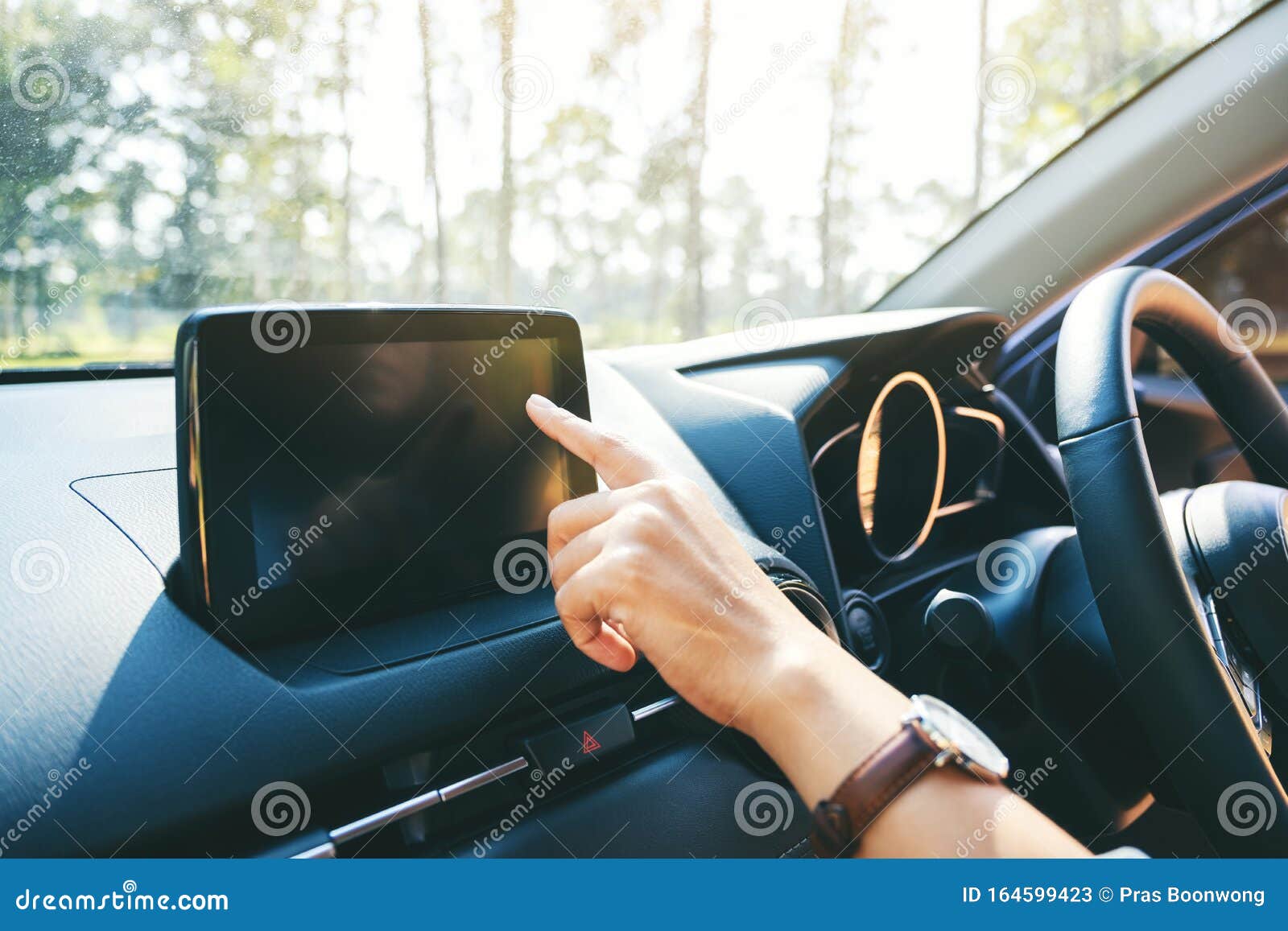 A Woman Using and Pointing Finger at Navigation Screen while Driving ...