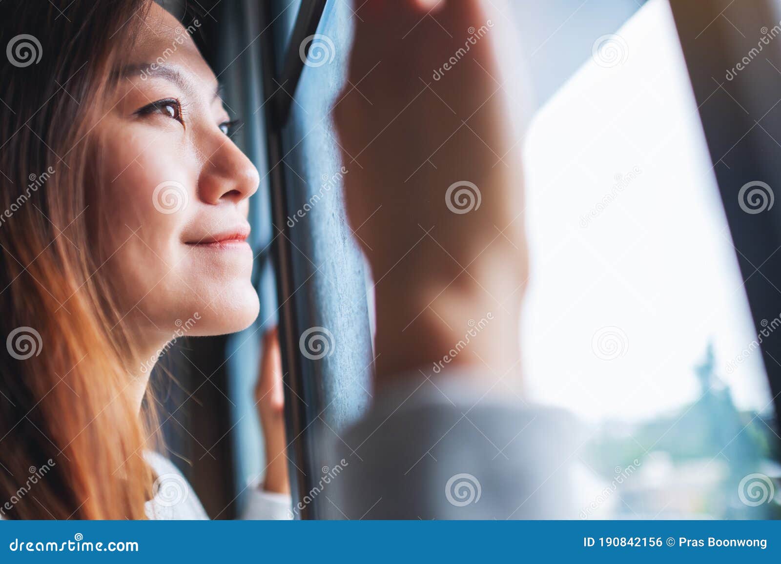 A Young Woman Touching On Window While Looking Outside Stock Photo ...